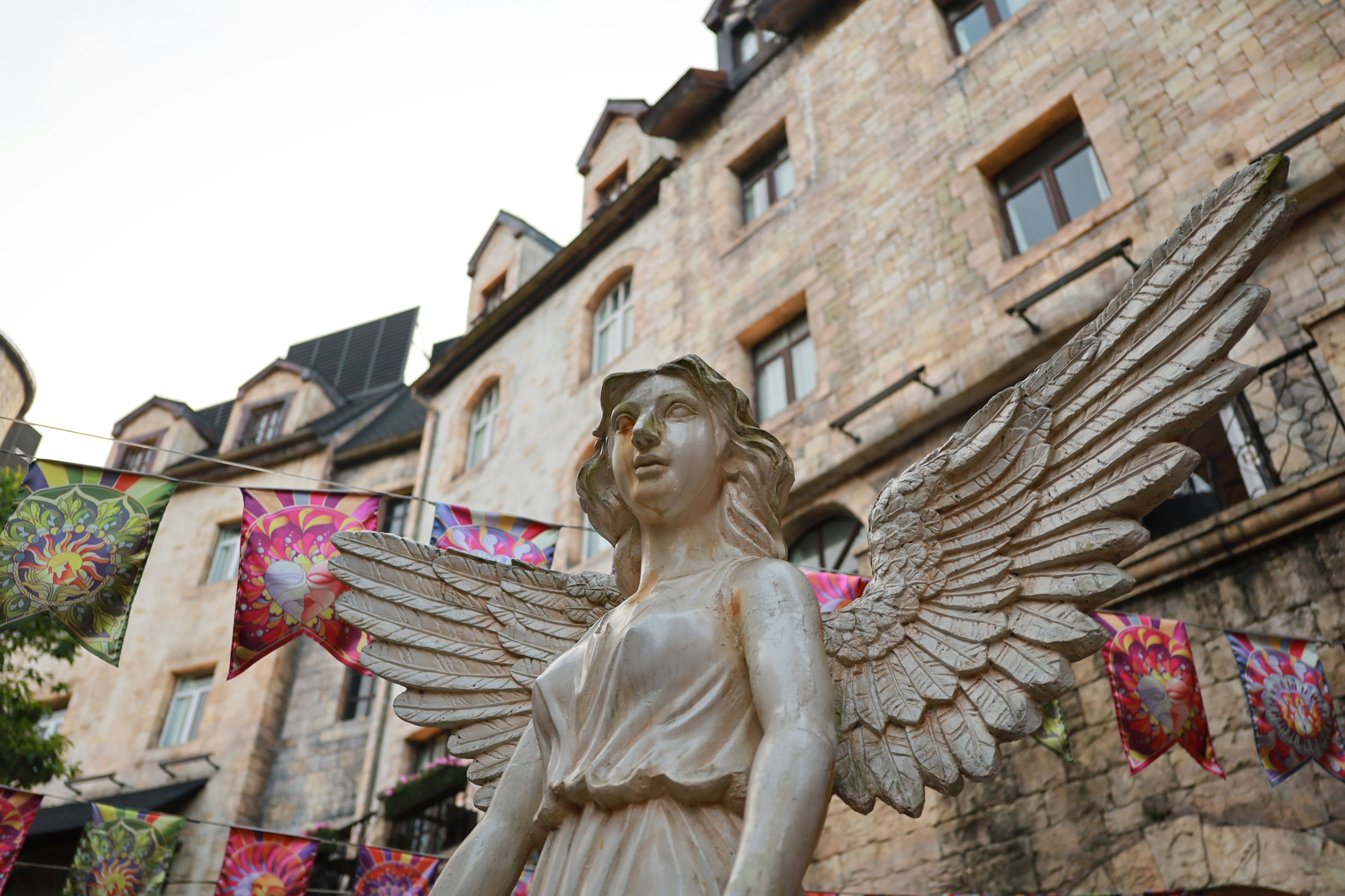 Winged Guardian amid Colorful Festooned Facade