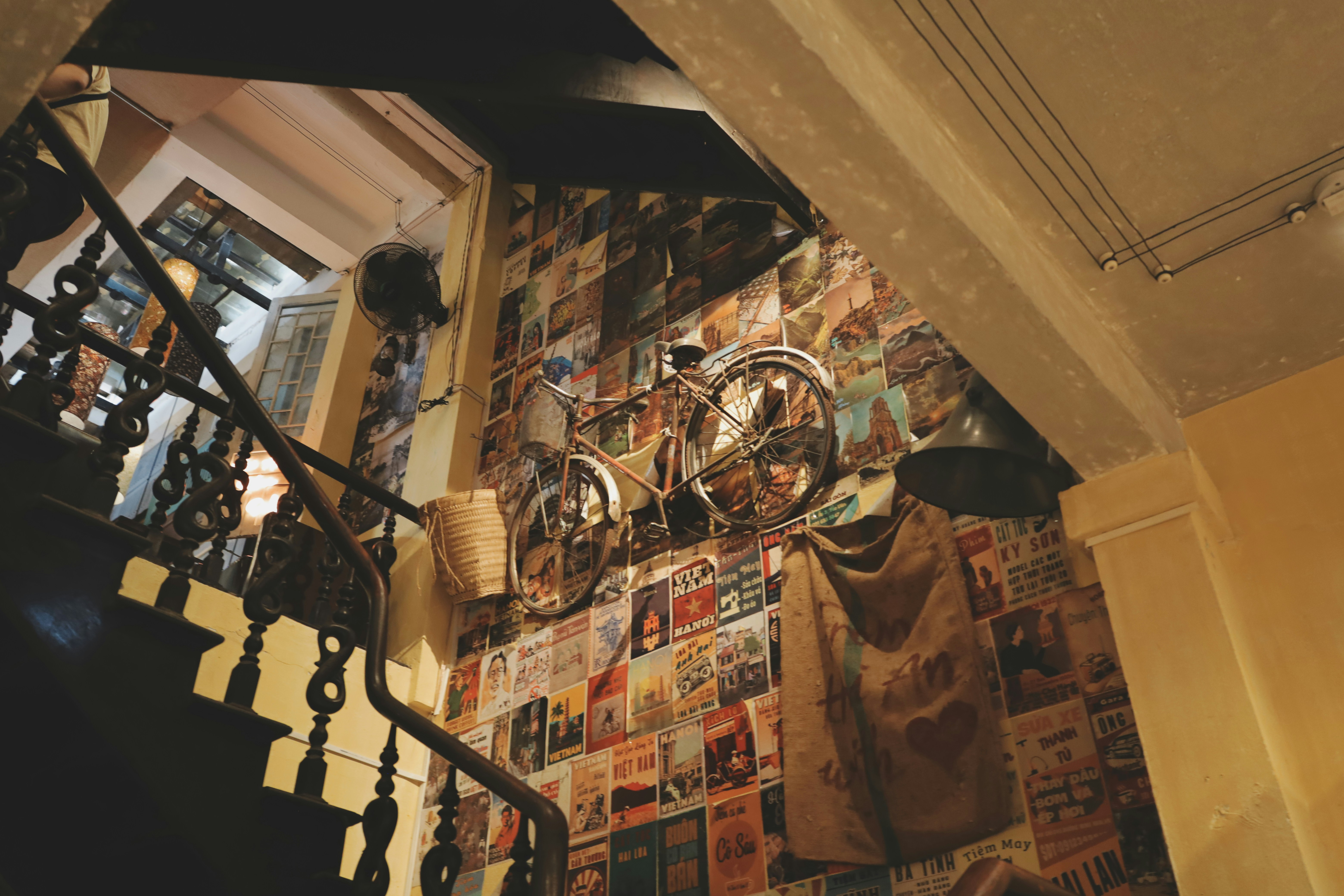 Retro Bicycle TV Wall: A Twilight Stairwell of Posters