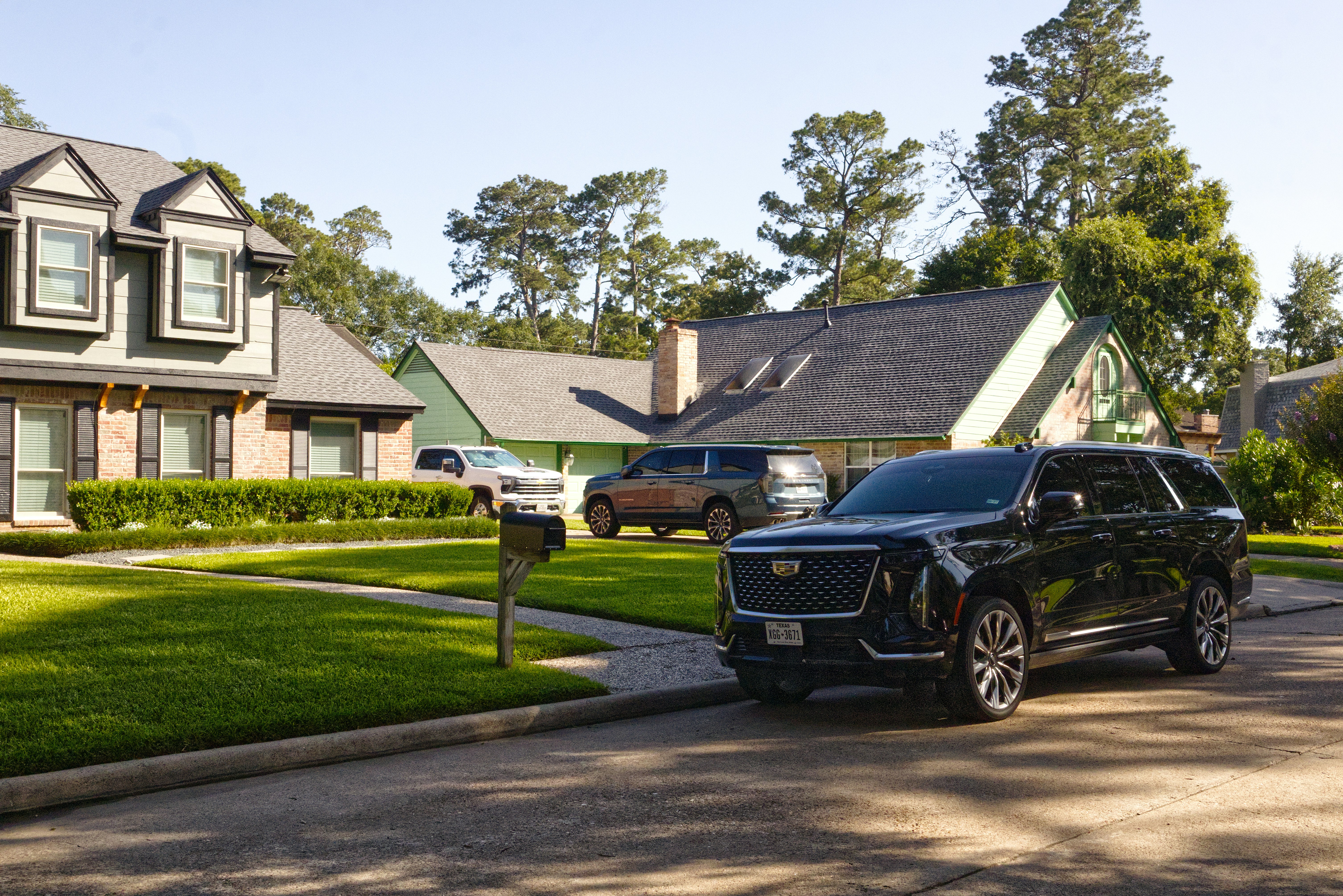 Cadillac Escalade parked in front of a house.
