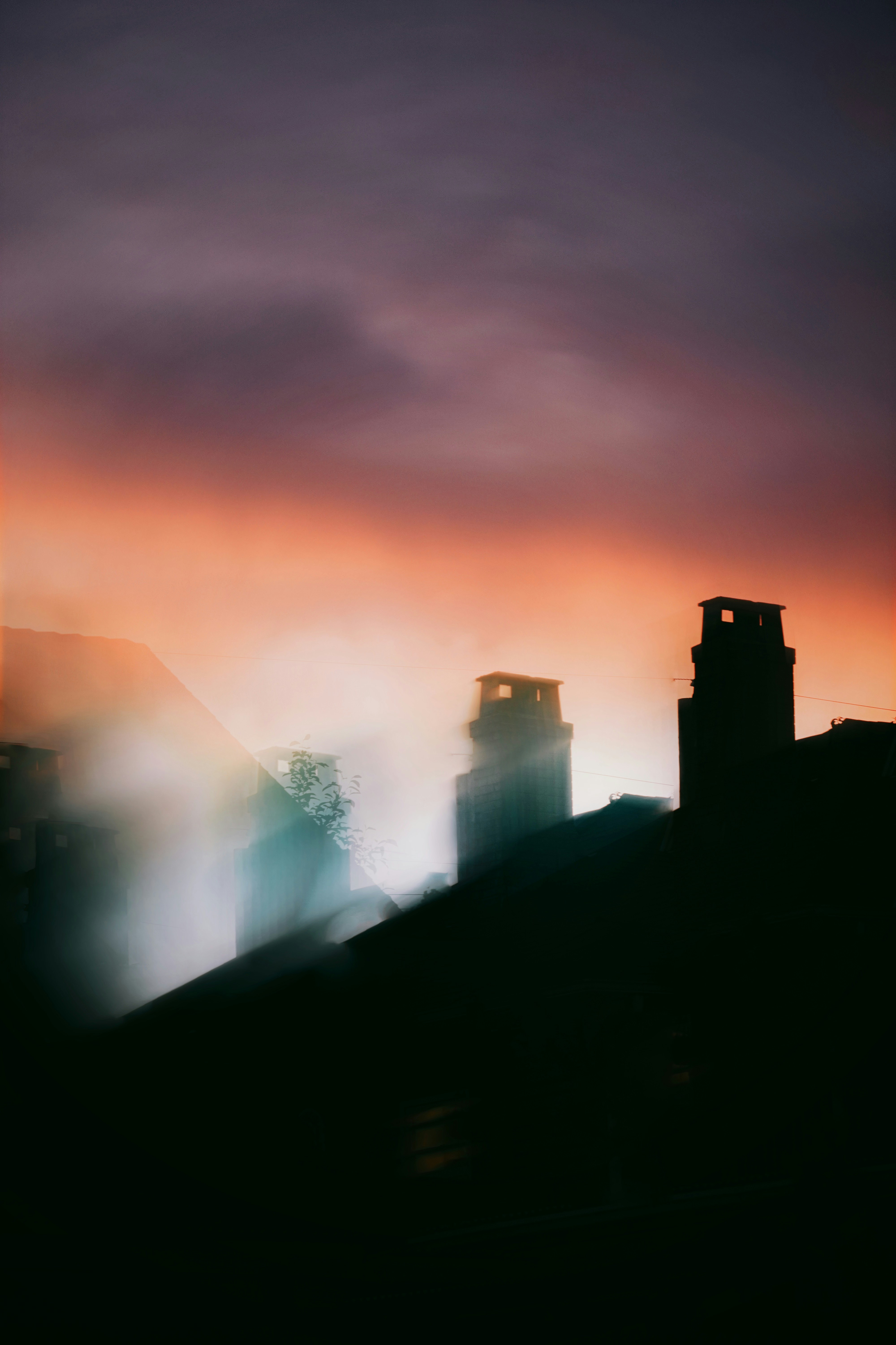 Chimney Silhouettes Against a Neon Sunset