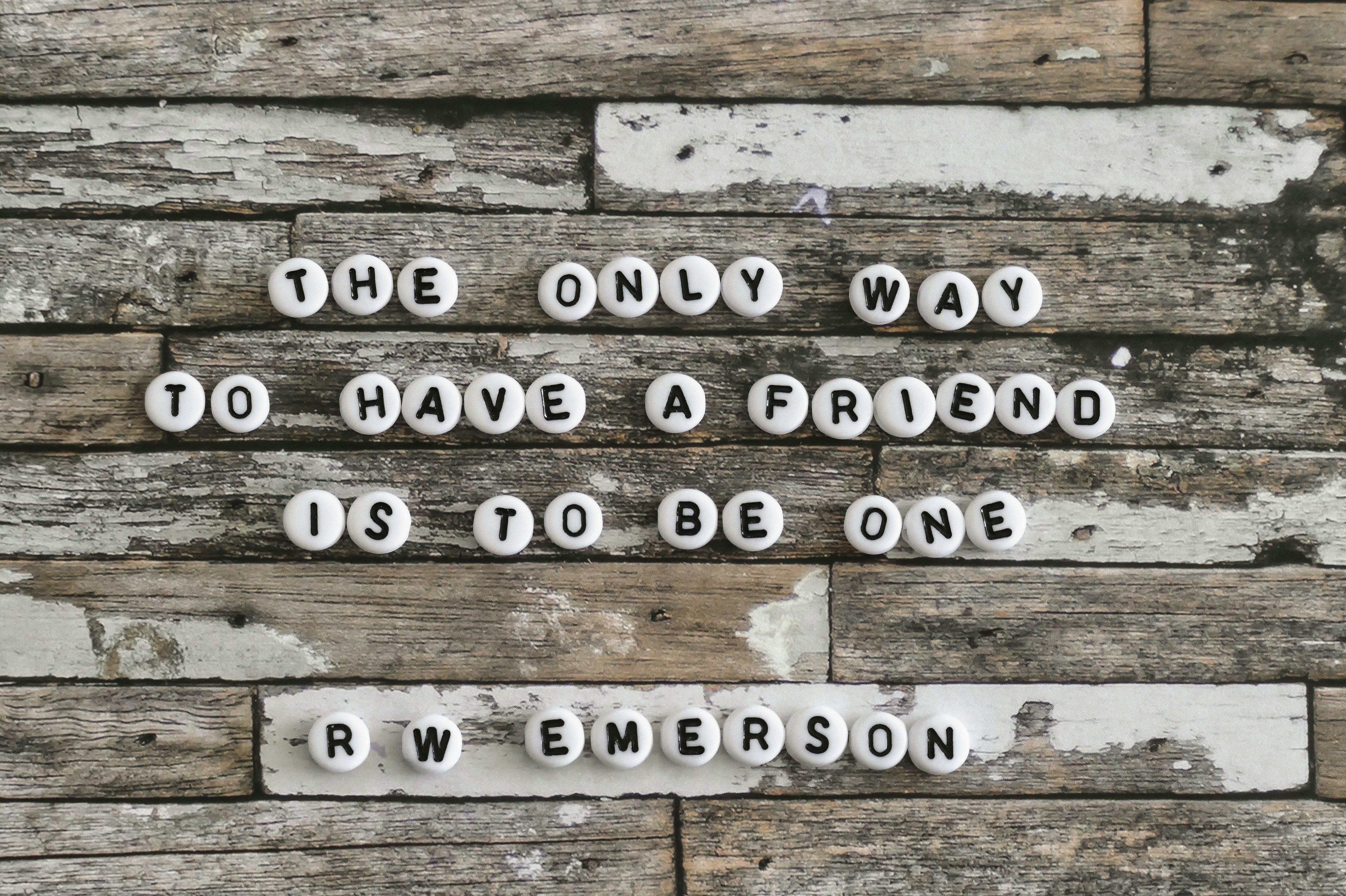 Quote about friendship by r w emerson on rustic wood.