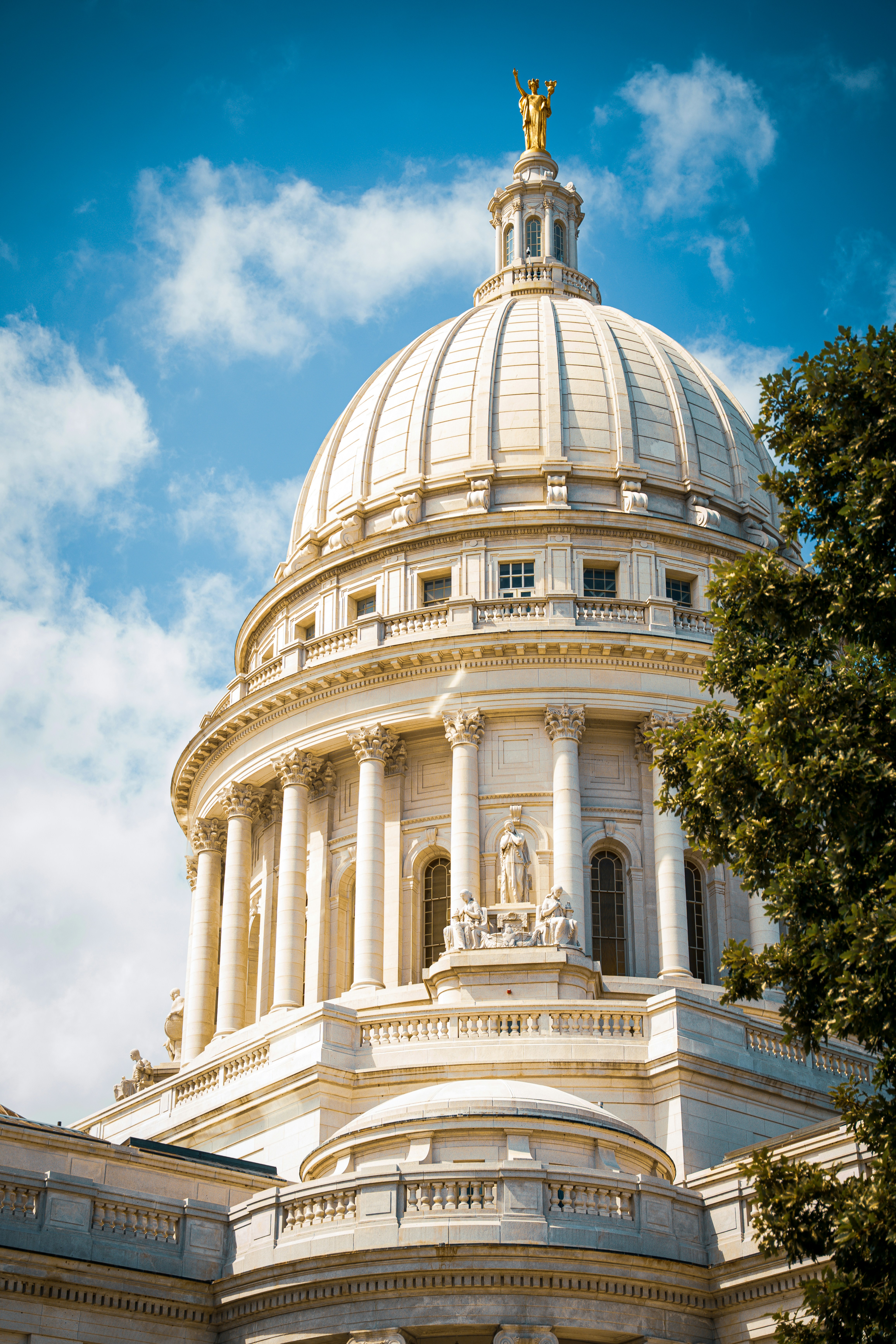 The Wisconsin State Capitol building rises into the frame in this summer photo