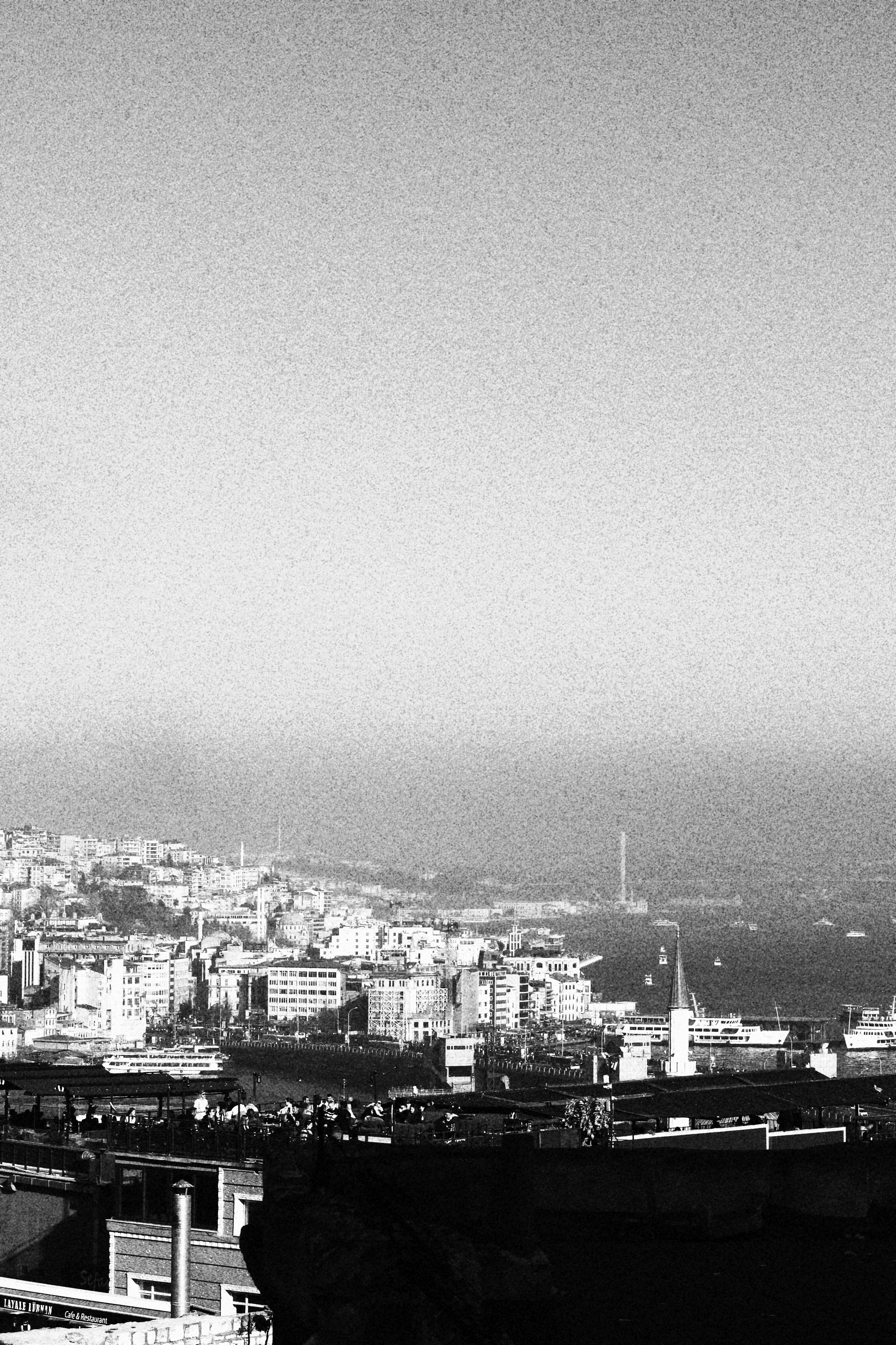 Quiet Coastal City Silhouette Beneath a Grainy Sky