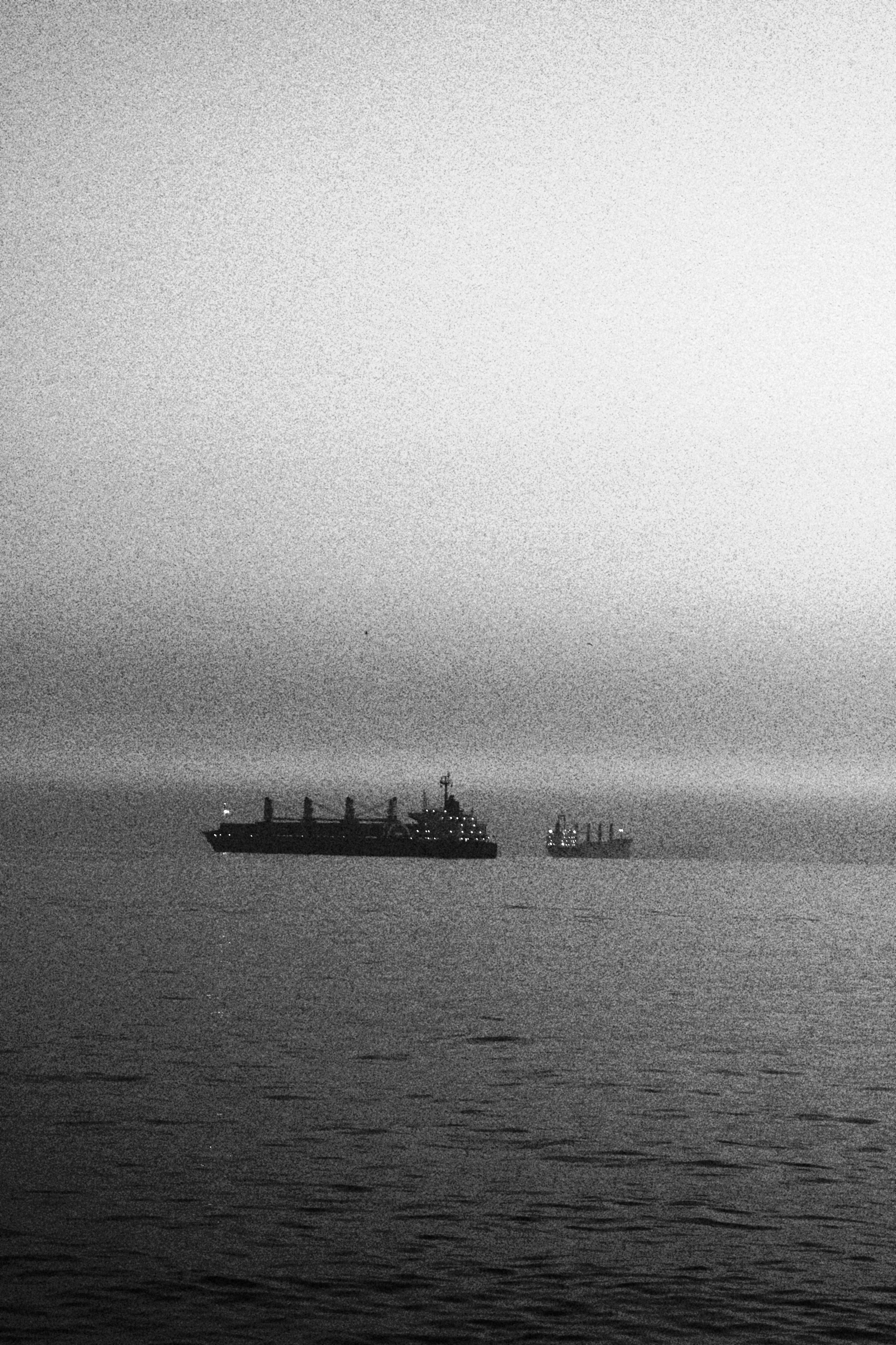 Silhouetted Freight Ships at Dusk