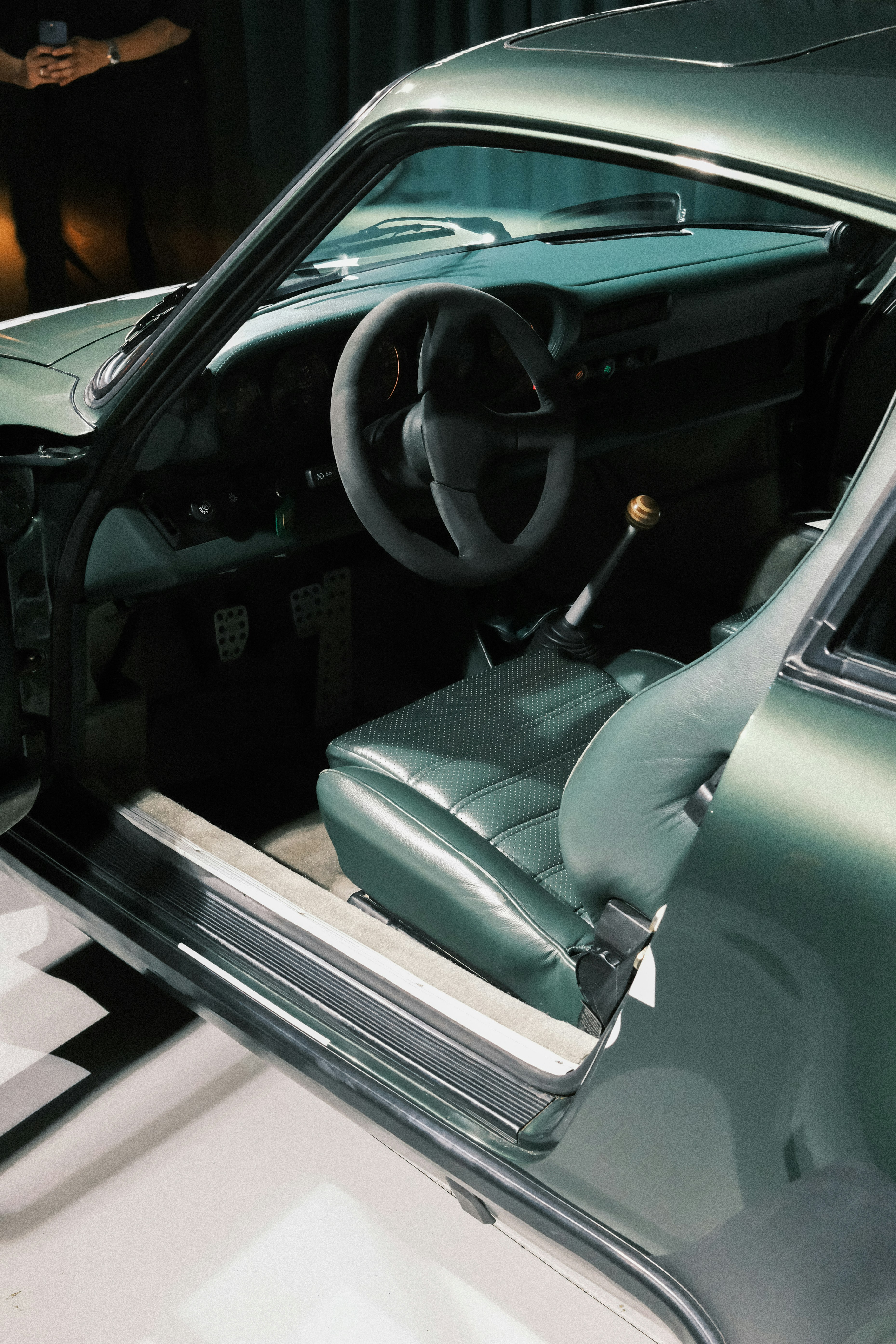 Interior view of a classic dark green sports car.