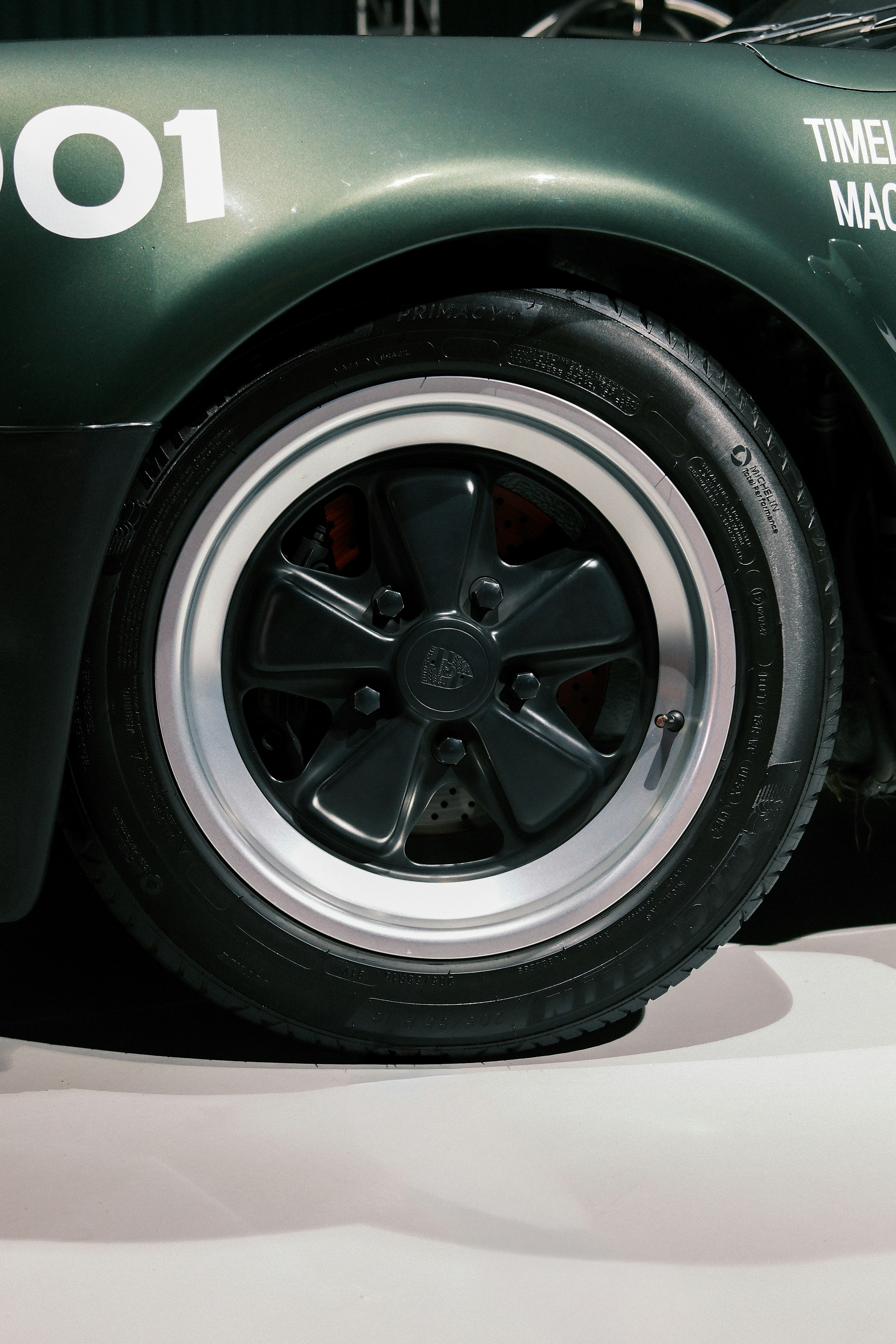 Green Racing Car Wheel: Precision and Shadowed Details