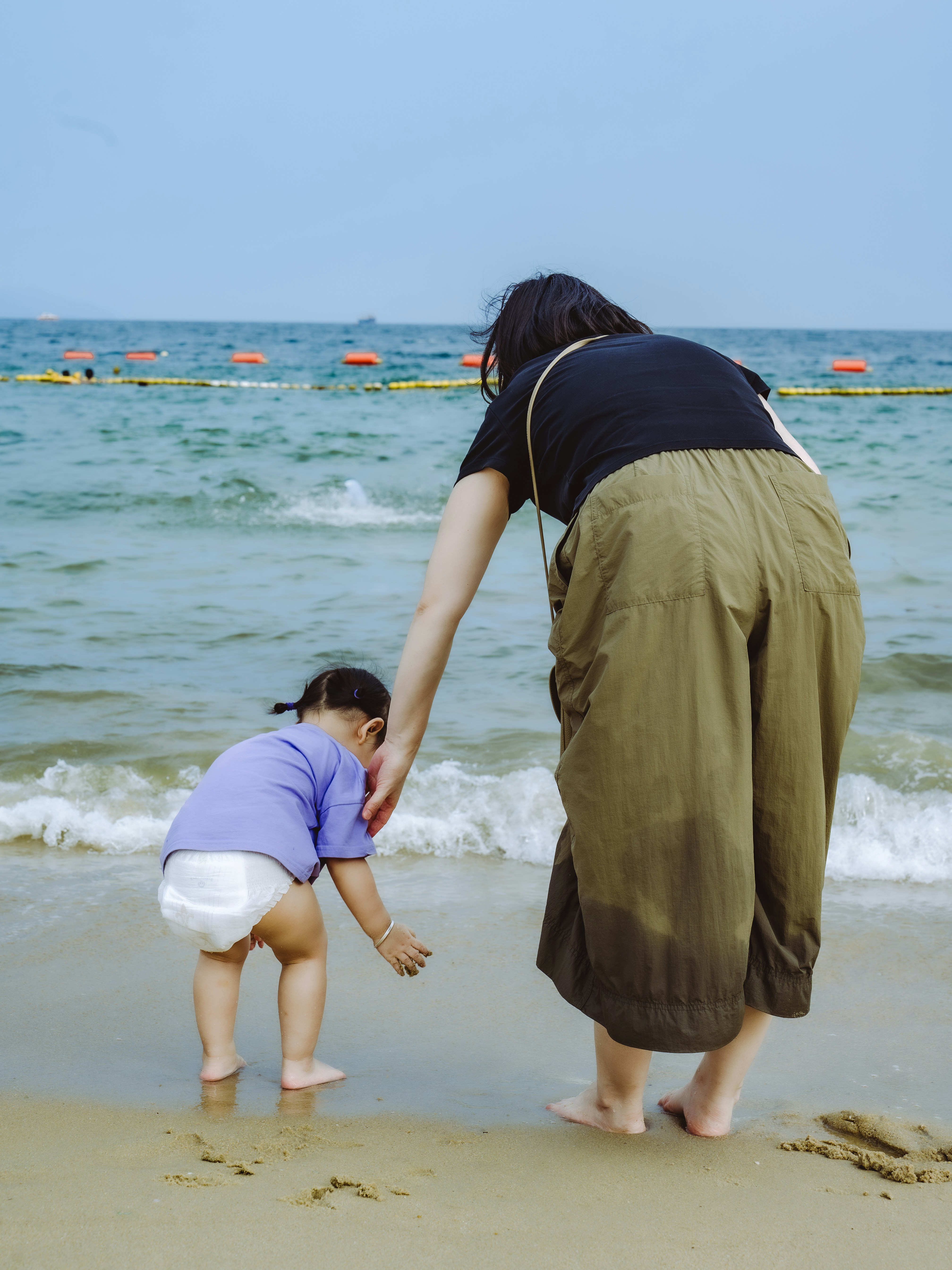 Two Figures at the Tidal Edge: A Careful Moment by the Sea