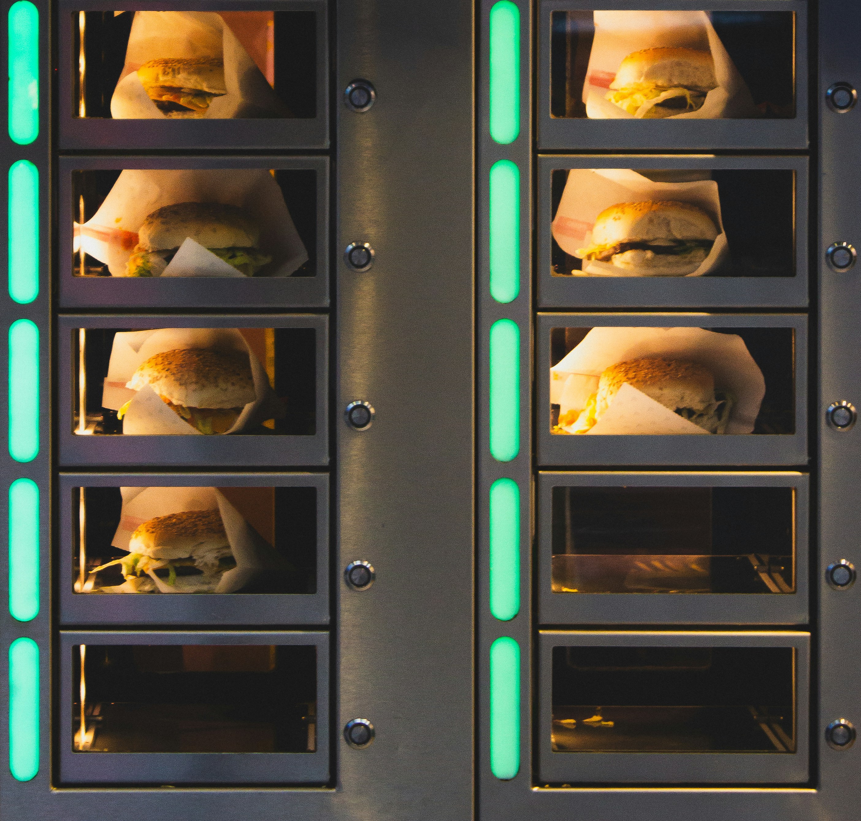 Parallel Snack Doors: A Neon-Lit Row of Mini Burgers Waiting Behind Green Stripes
