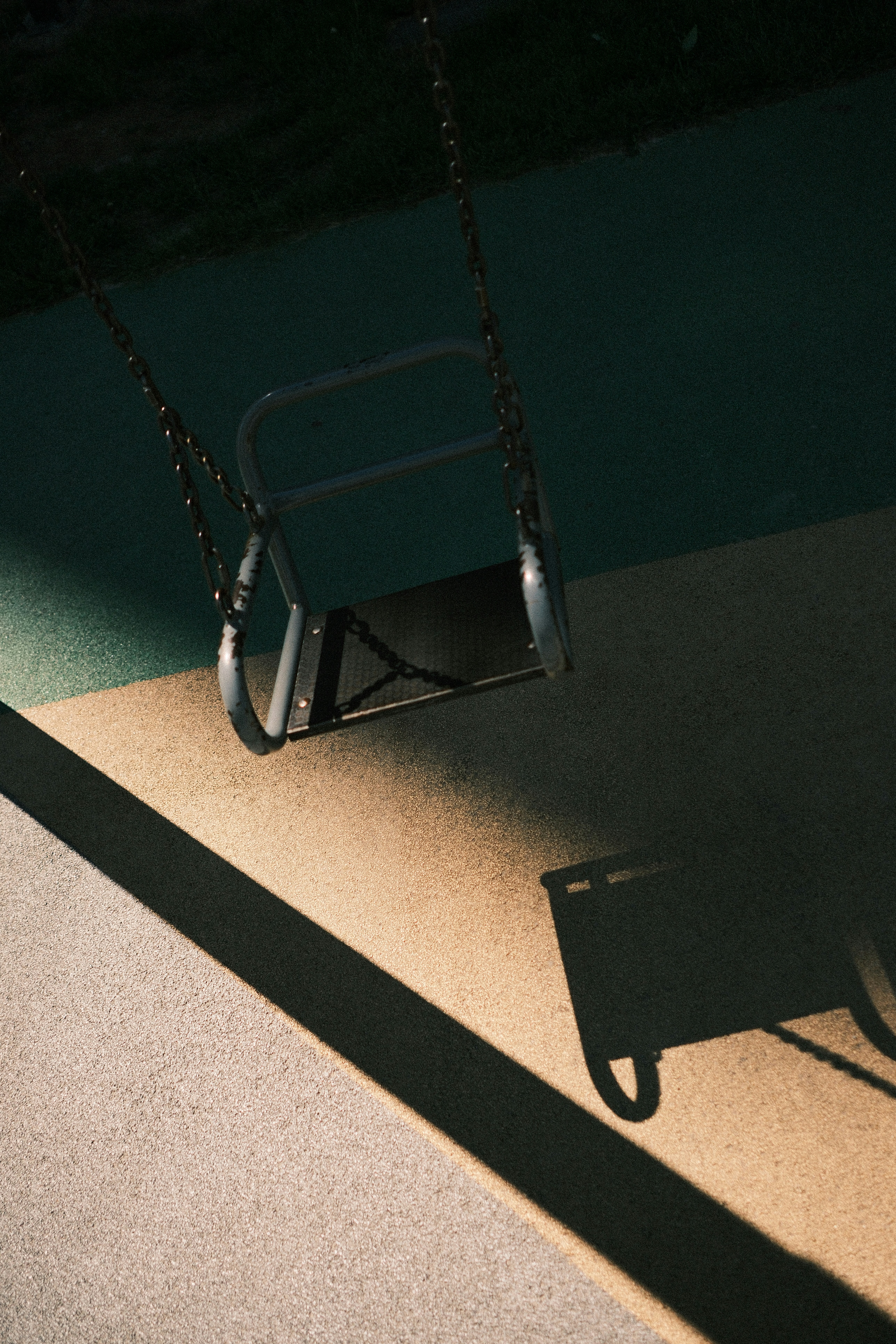 Solitary Playground Swing Casting a Long Shadow