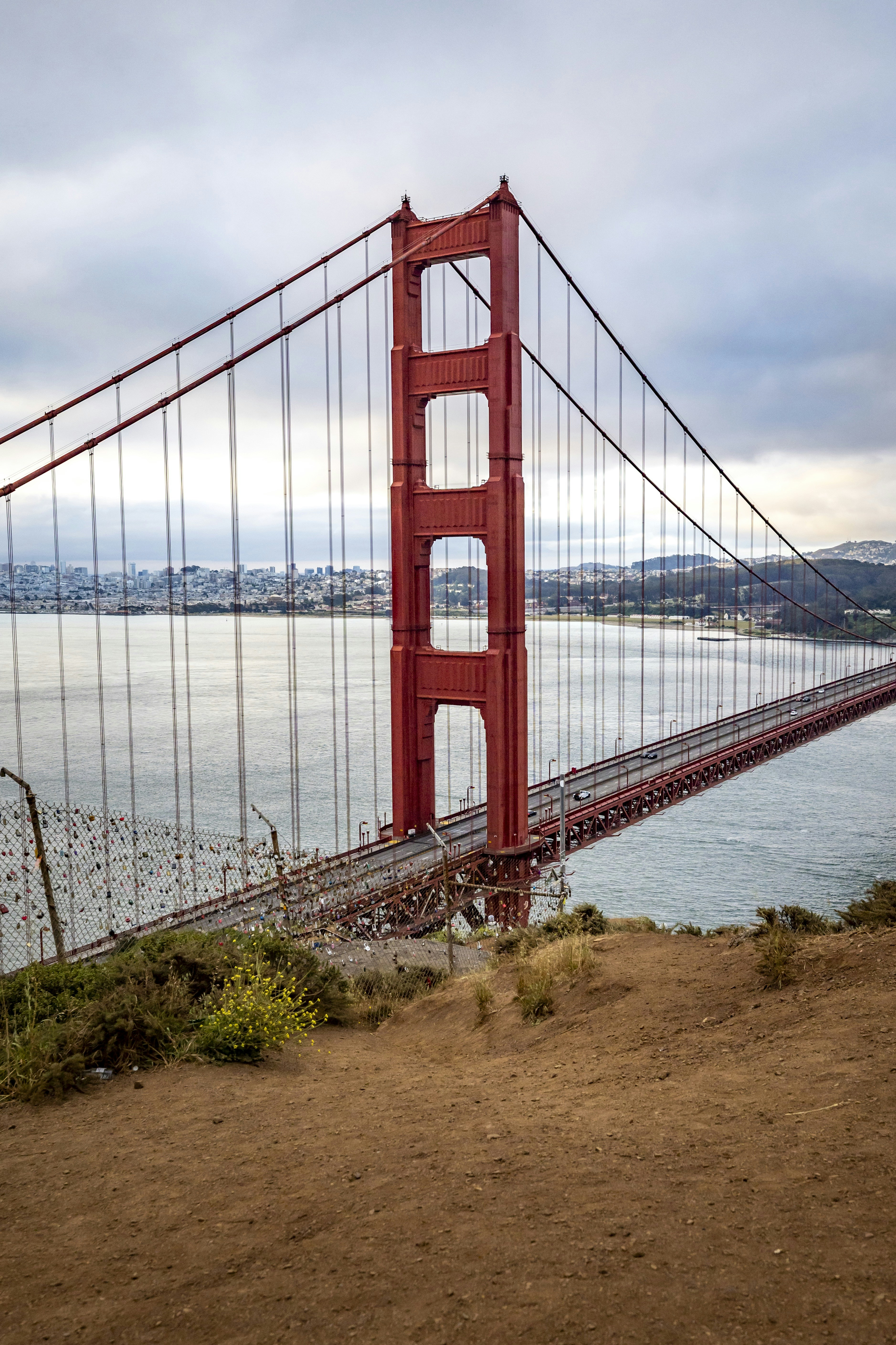 Iconic golden gate bridge under a dramatic cloudy sky.