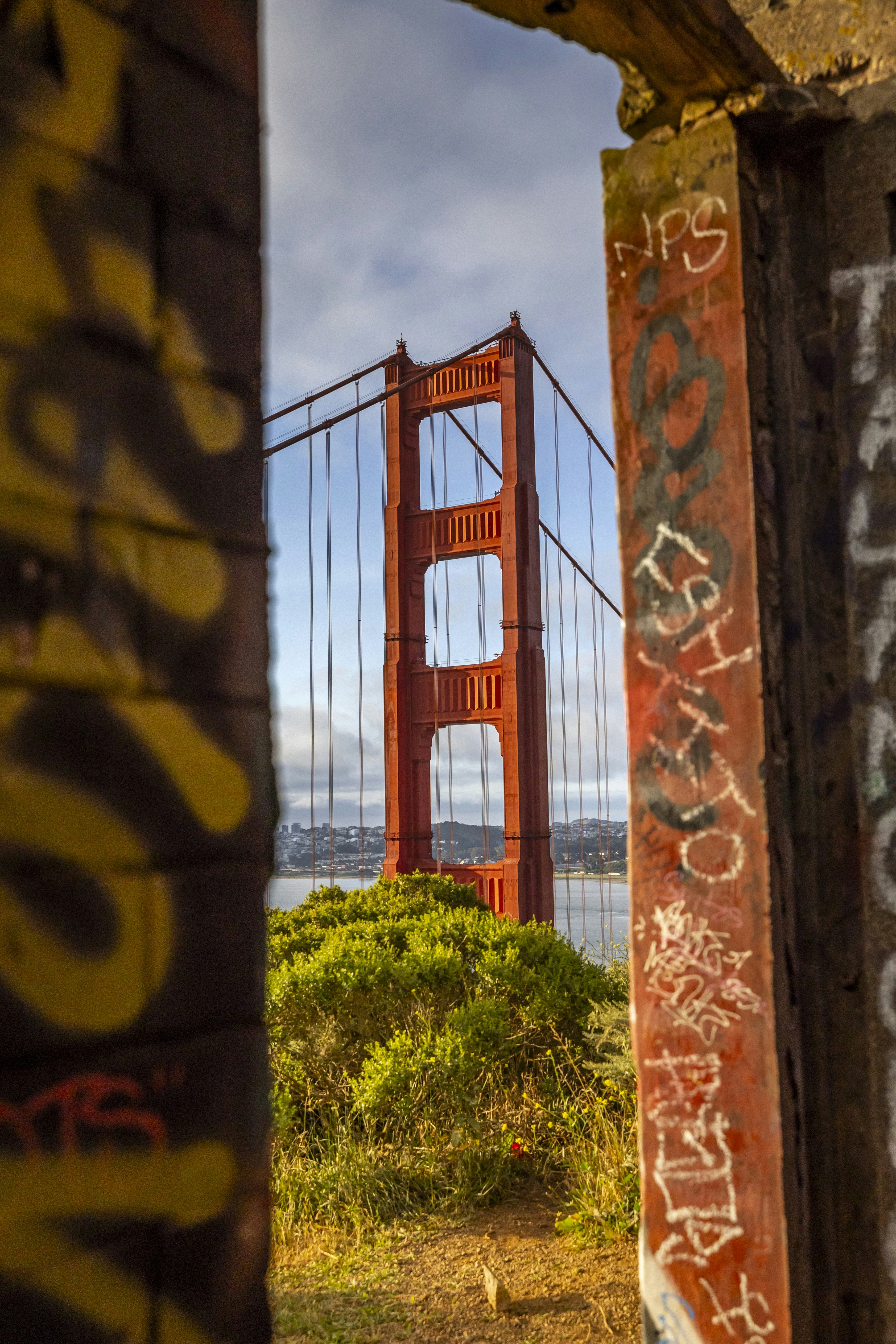 Golden gate bridge framed by a graffiti-covered doorway.