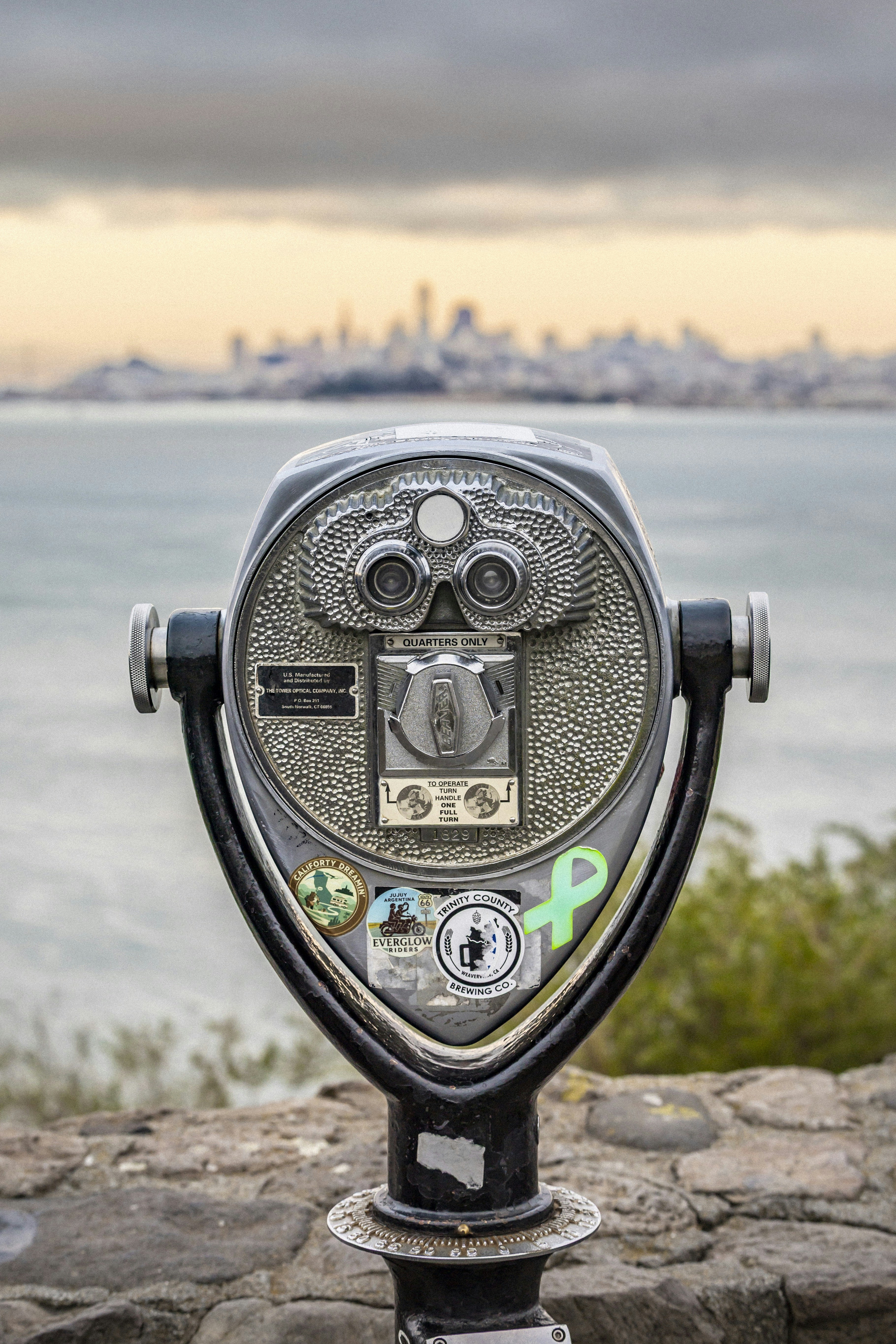 Public Viewfinder: A Close-Up of a Coin-Stamped Binocular Viewer Overlooking the Bay