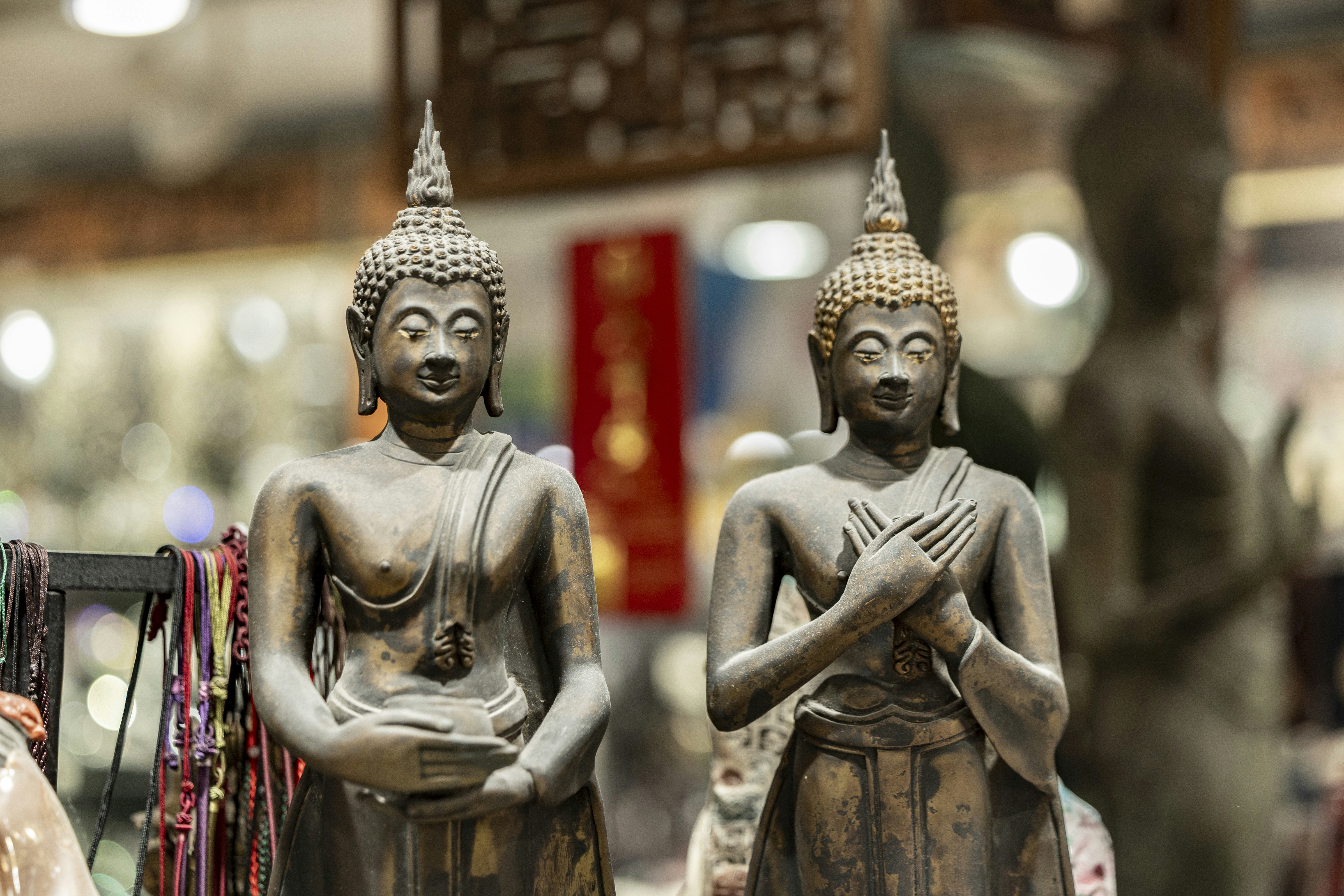 Two buddha statues standing side by side.