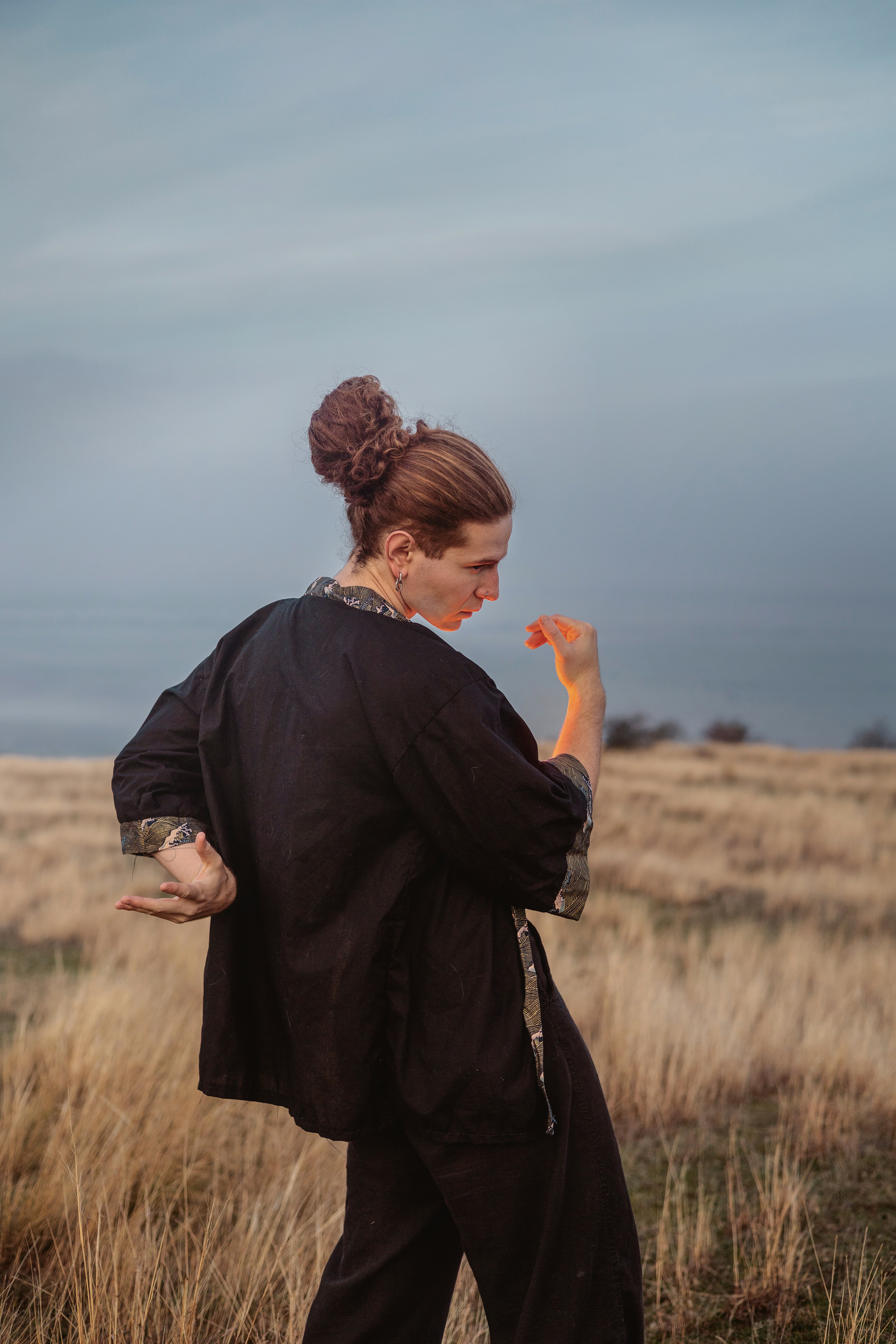 Portrait in Wind: A Woman in Black in a Prairie Hugging the Horizon