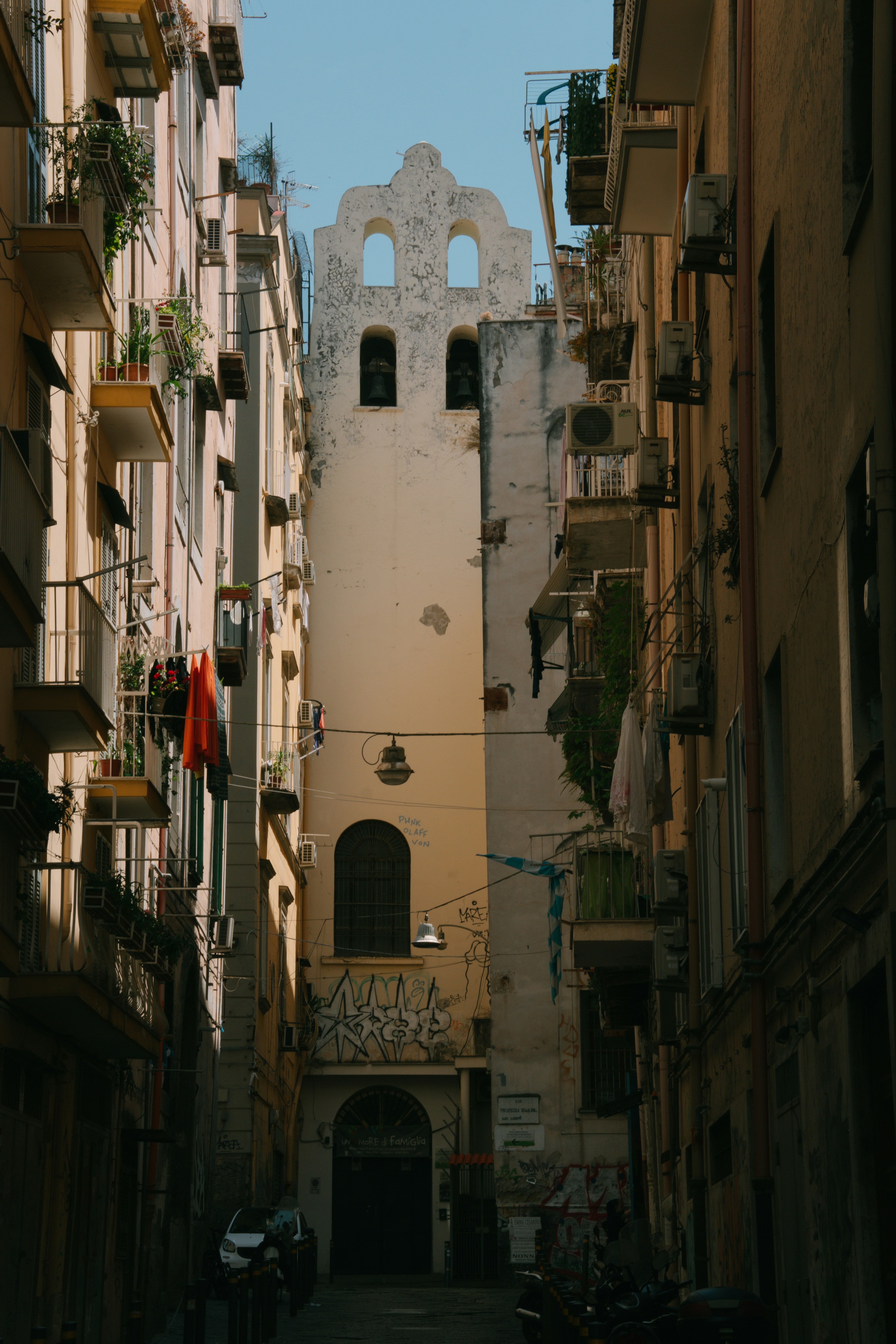 Sunlit Bell-Tower Vista Pierced by Urban Passage