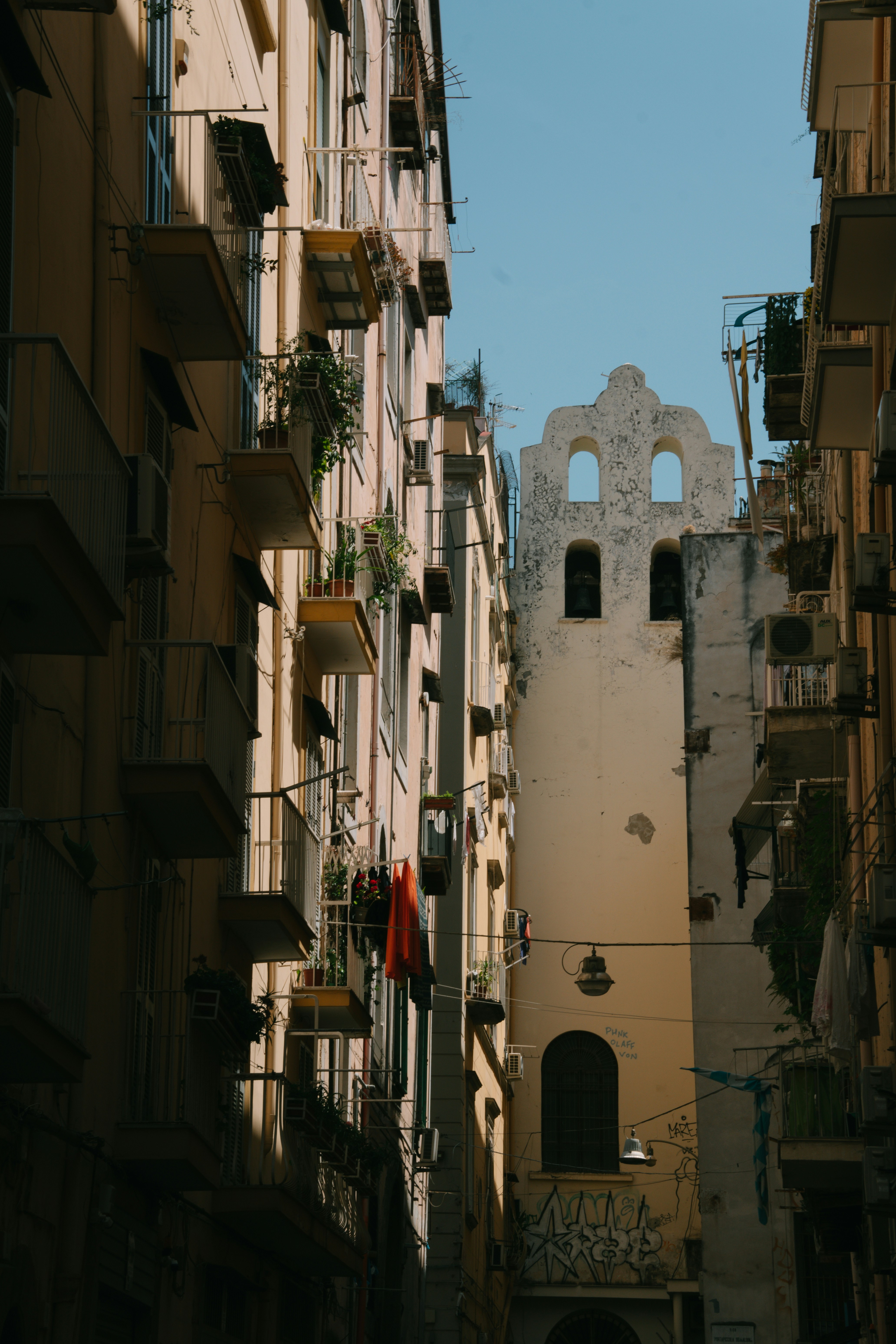 Cloistered Staircase to the Sky: A Narrow Arc of Light Between Towers