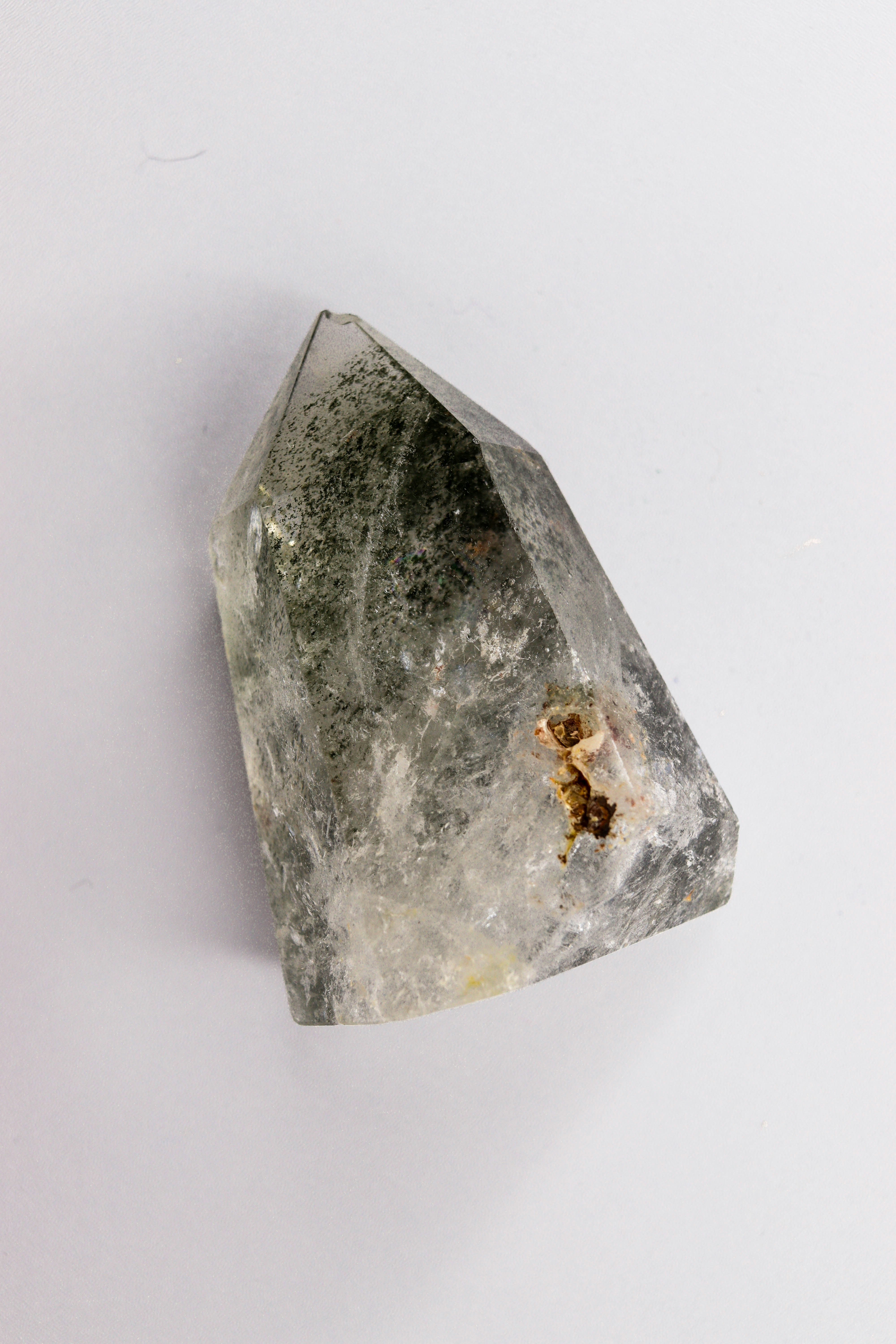 Crystal Prism: A solitary mineral shard resting on a pale backdrop