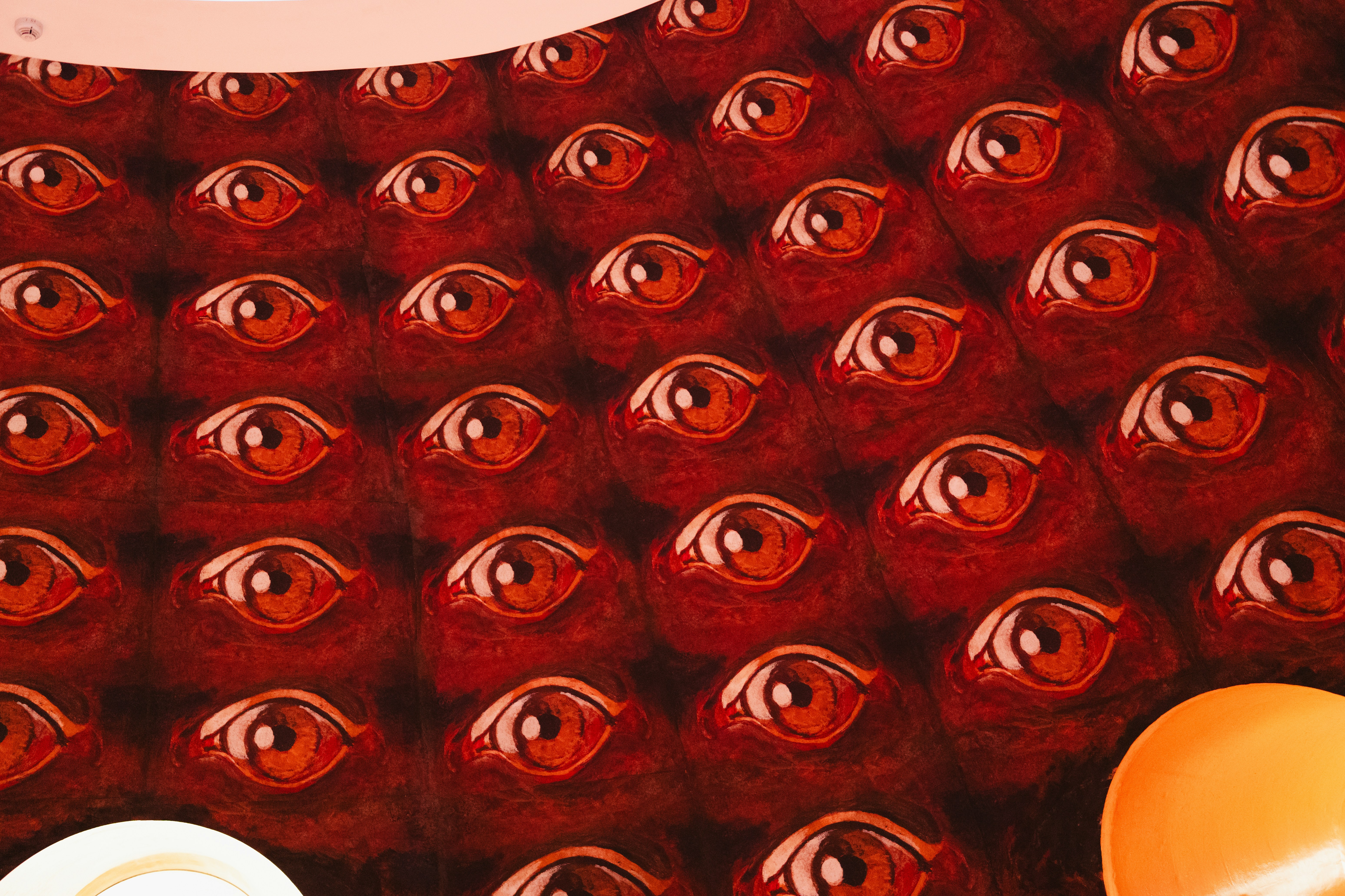 Red-Eye Orchard: A Patterned Wall of Vigilant Orbs
