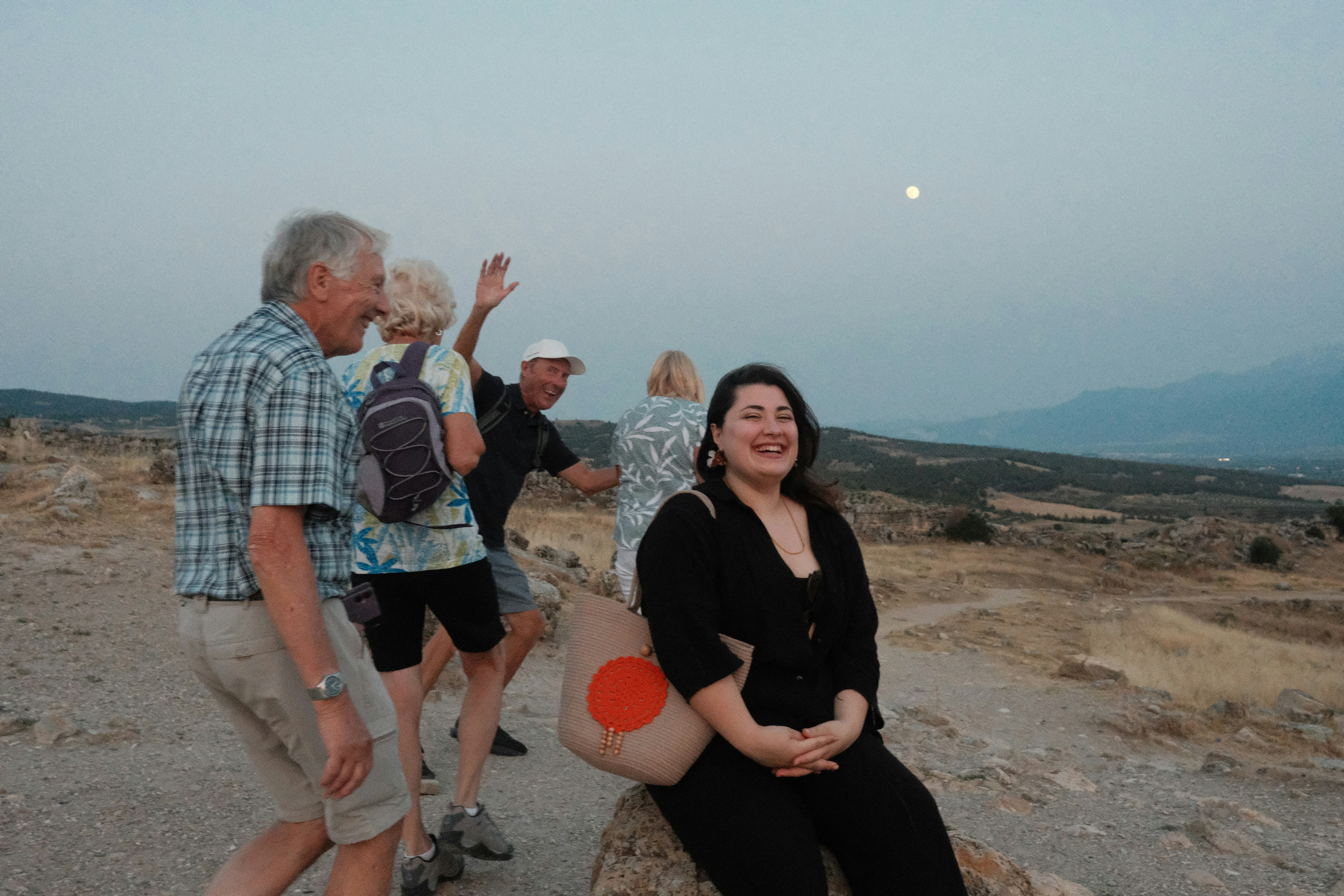 Evening Calm at the Edge: A Small Group Pauses by the Horizon