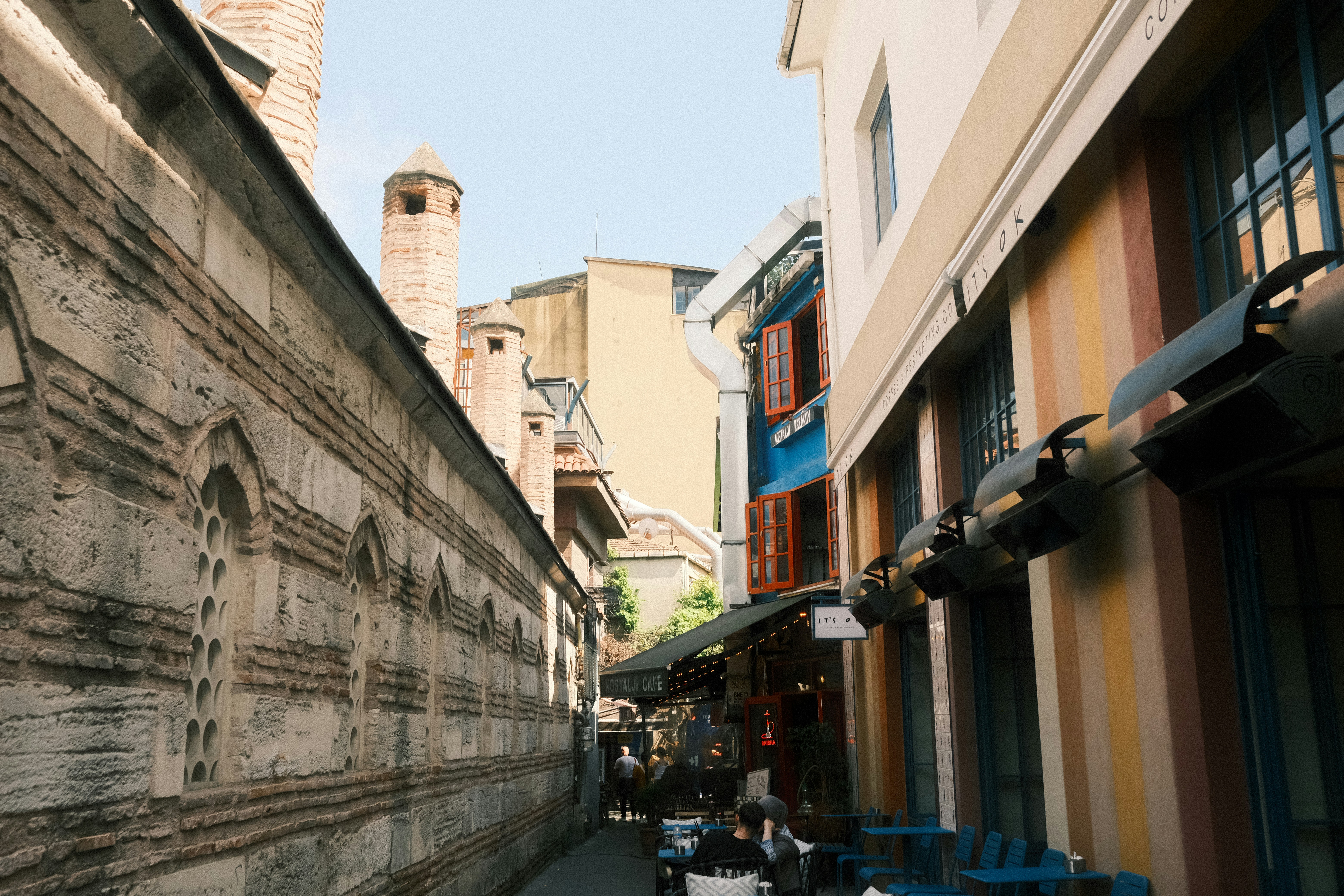 Quiet Alley Café Amid Historic Brick and Bright Facades