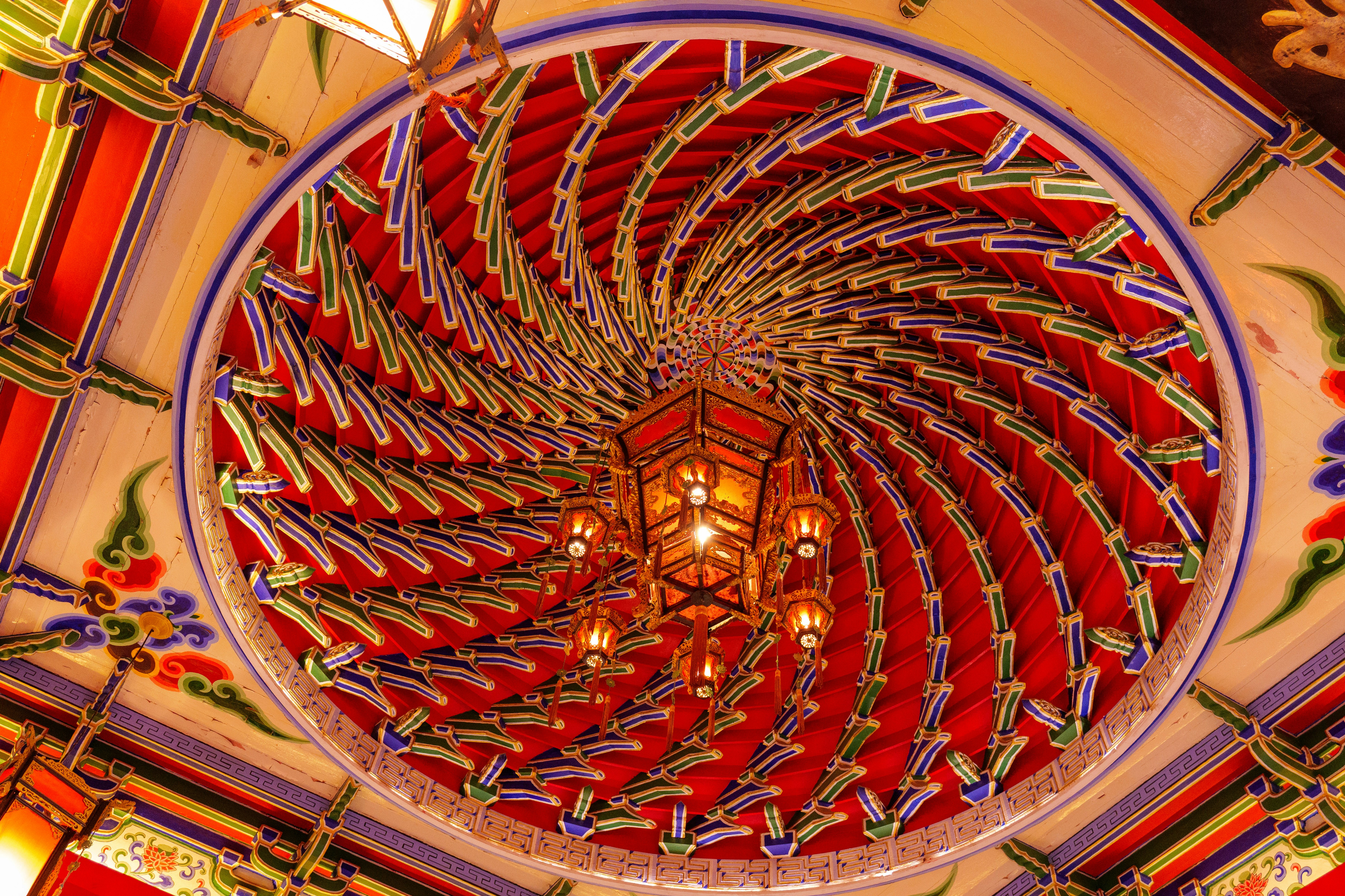 Spiral Lantern Chandelier: A Kaleidoscope of Color over a Circular Painted Ceiling