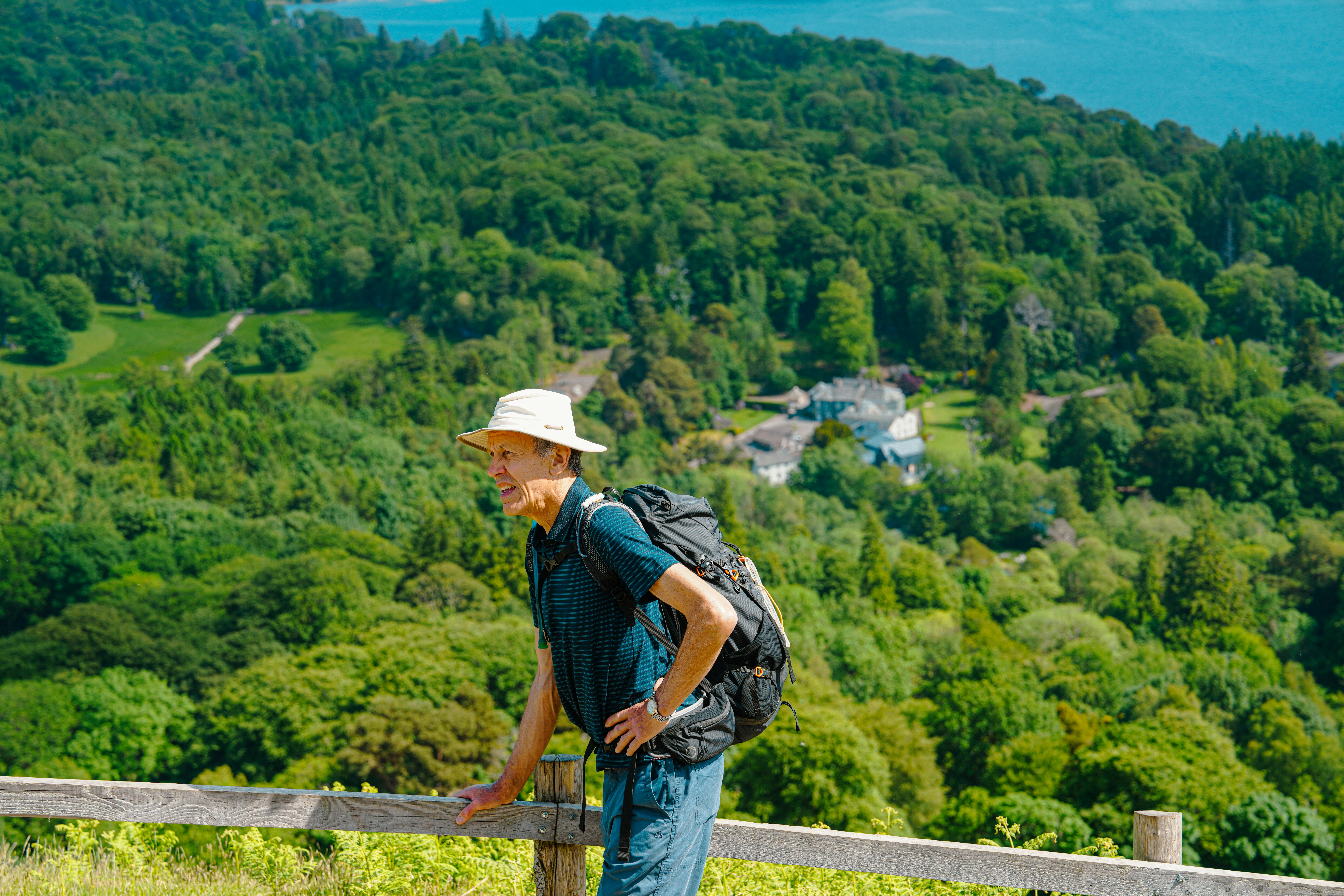 Hiker on the Ridge: A Quiet Pause Above the Green Sea