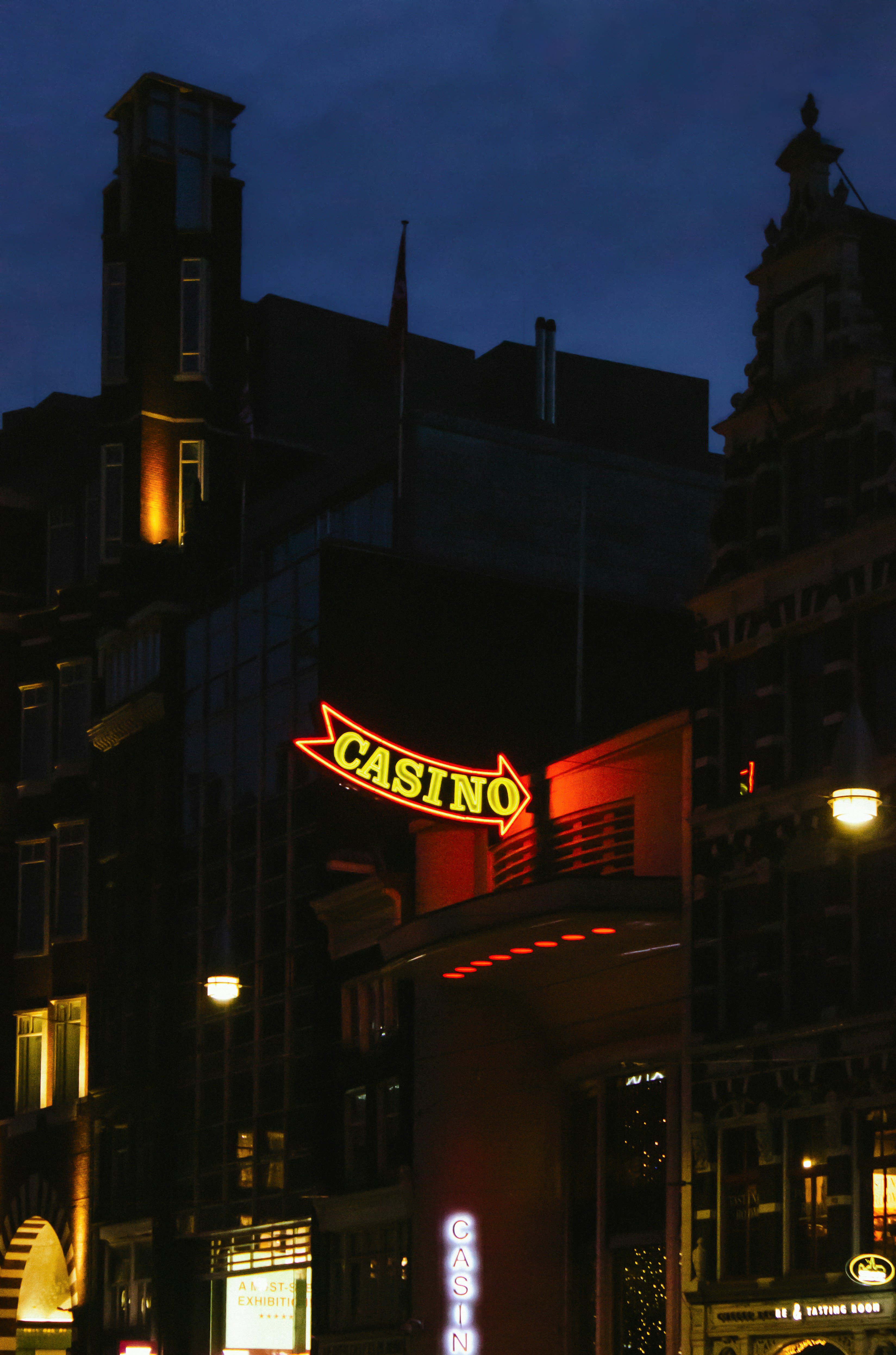 Neon Casino Sign Amid Historic Facades at Night