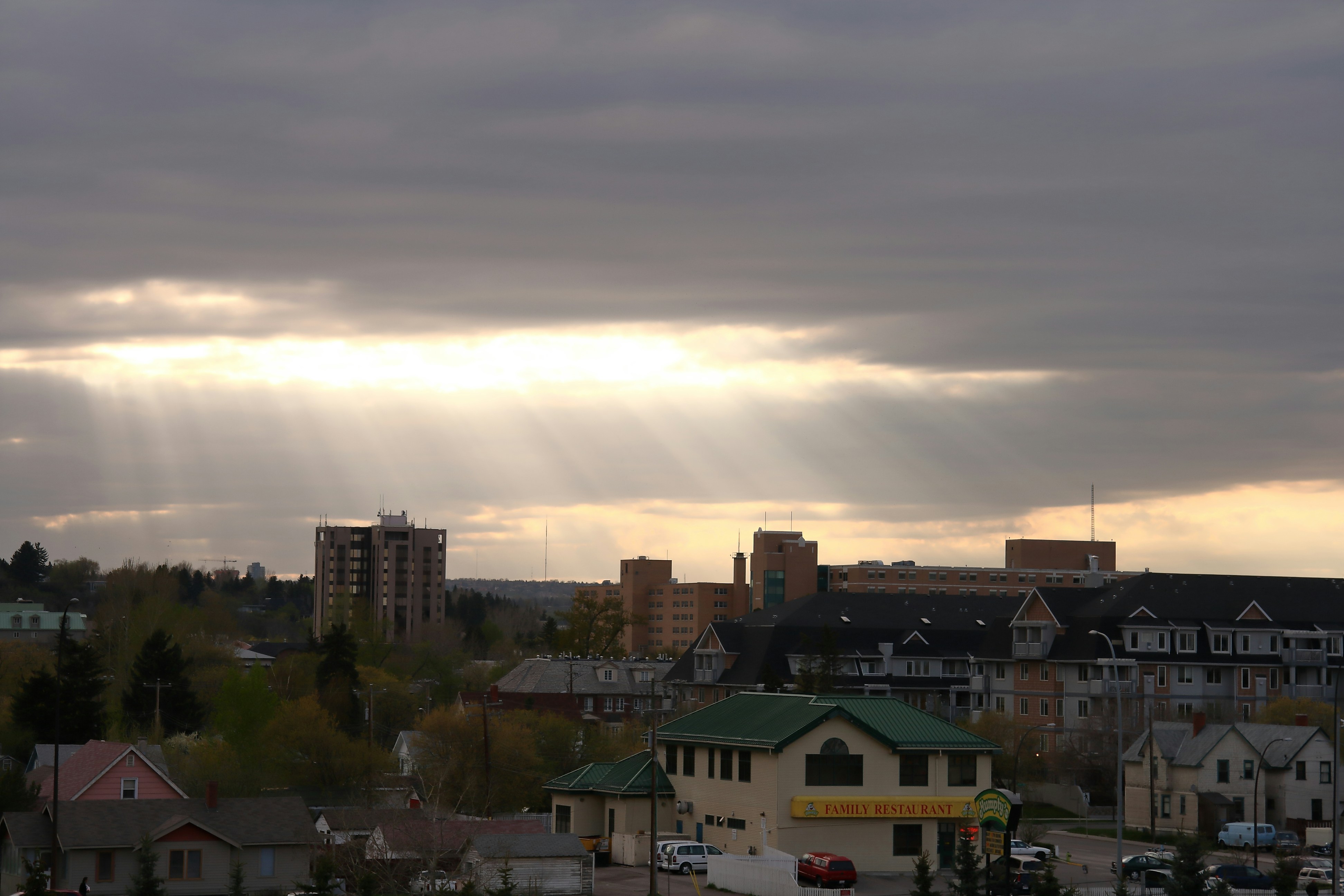 Rays Through a Somber City: Early Morning Light on Suburban Rooftops