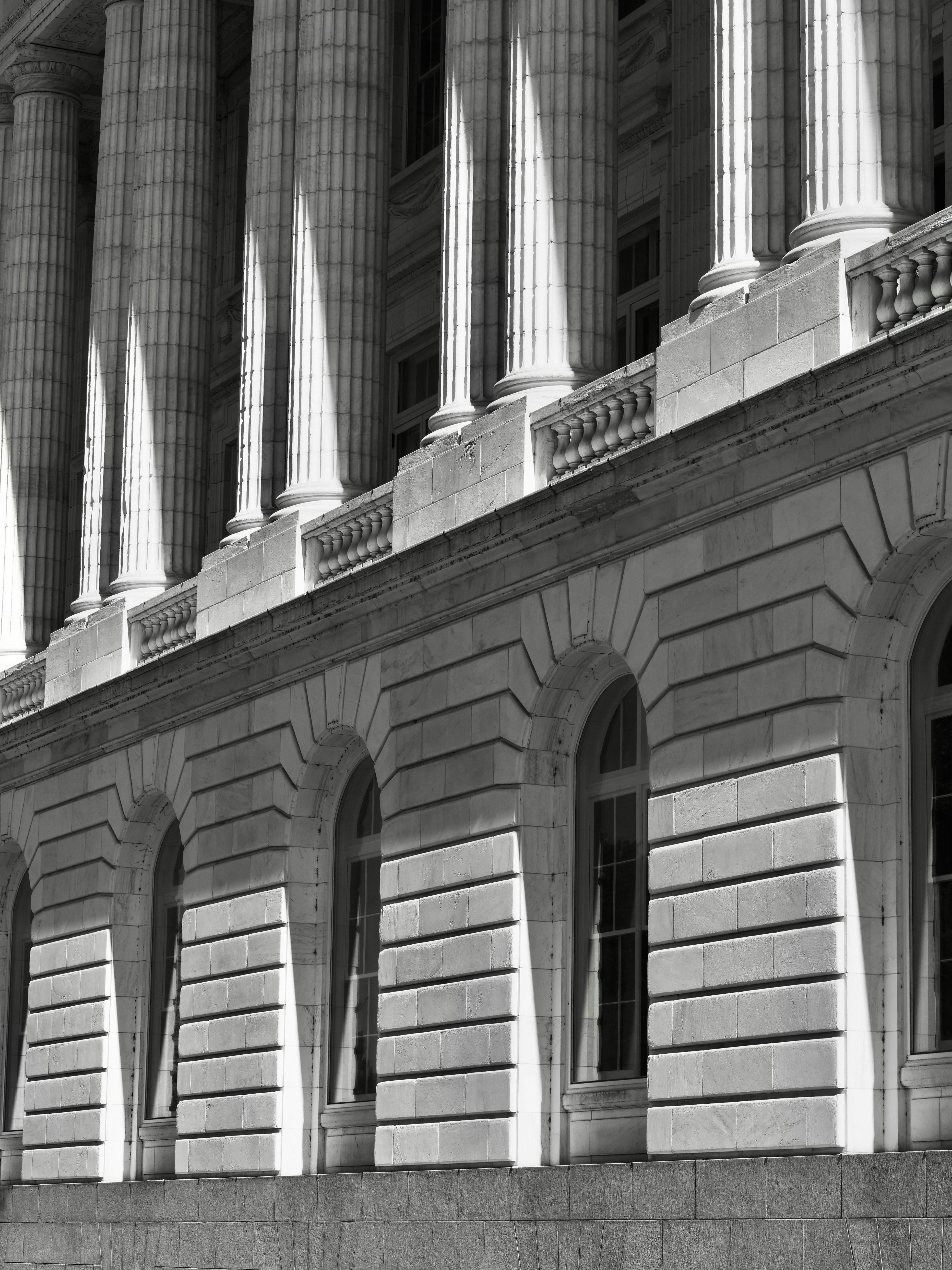 Stone Echoes: Colonnade Shadows along the City Facade