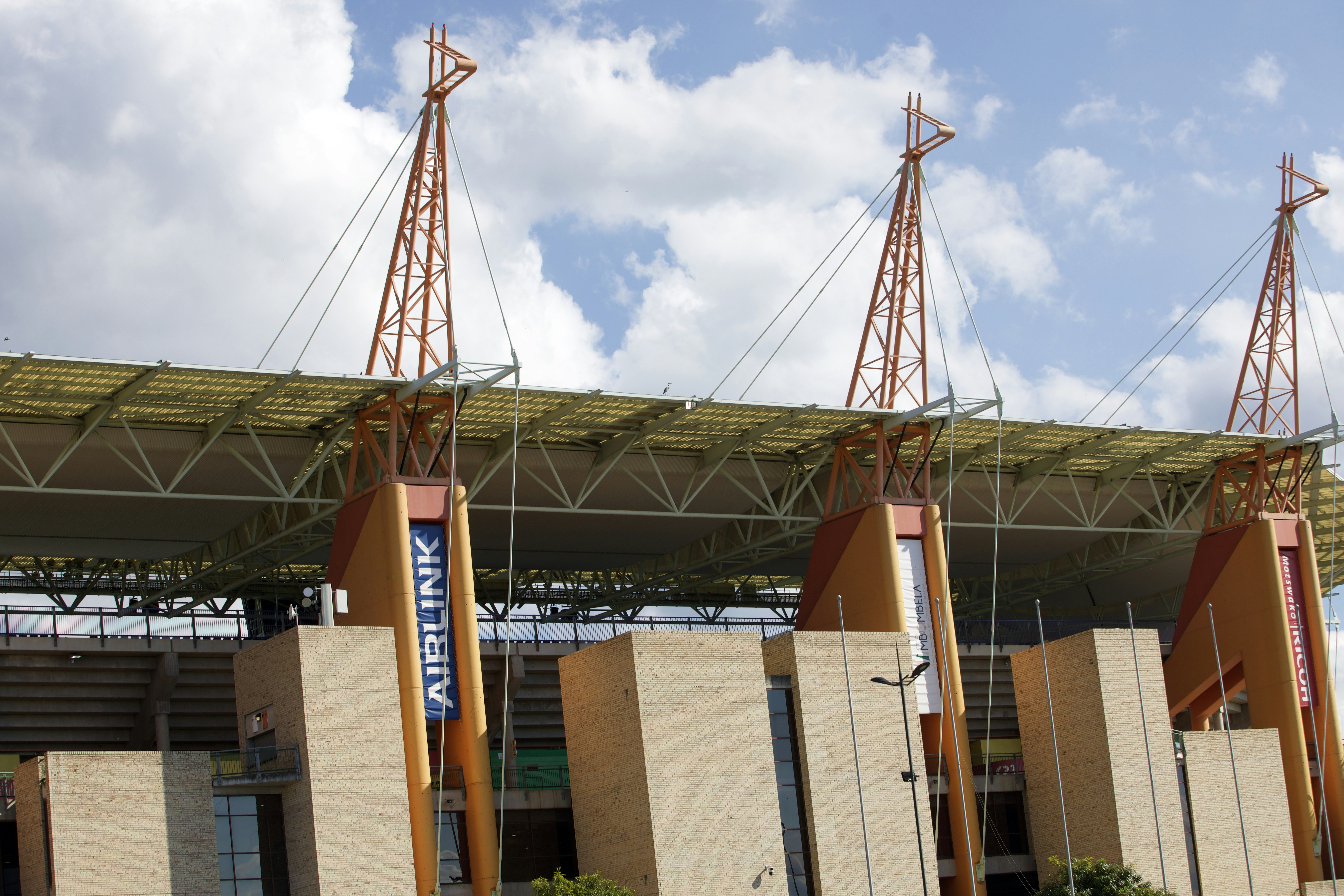 Industrial Stadium Facade Under a Bright Sky