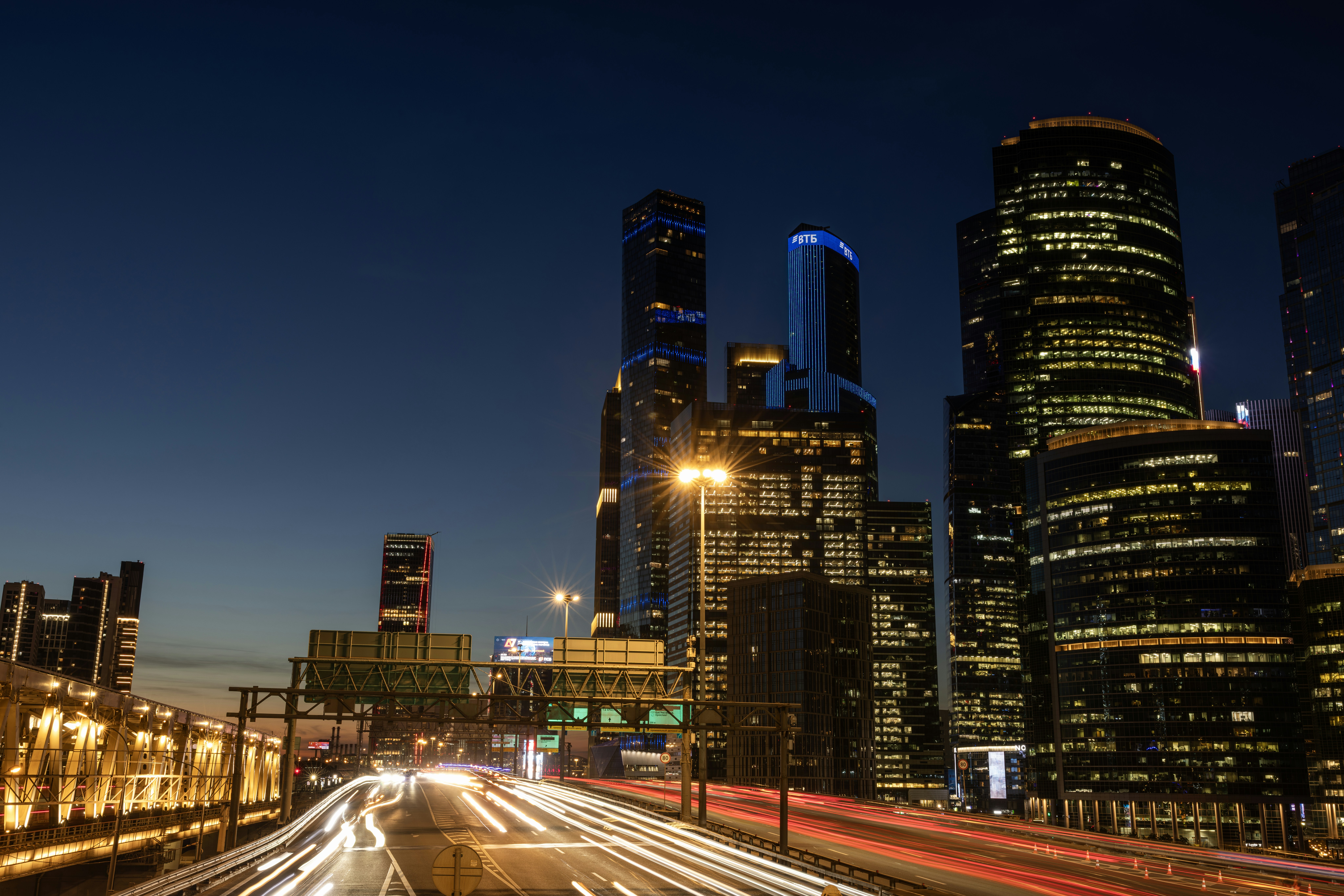 Urban Vigil: Nighttime Skyline Through Light Trails