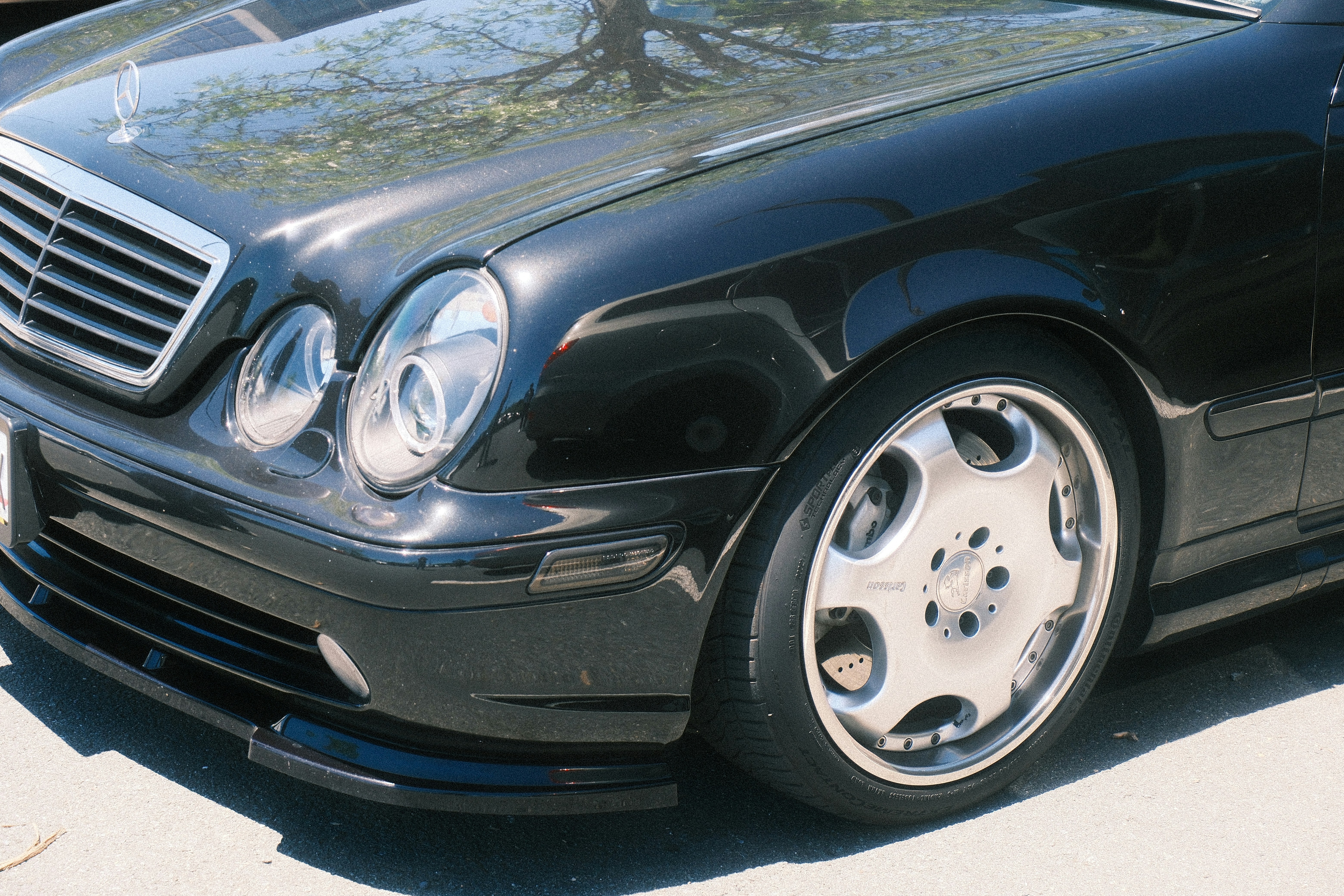 Low-Angle Glint: A Sleek Mercedes with Reflective Panels