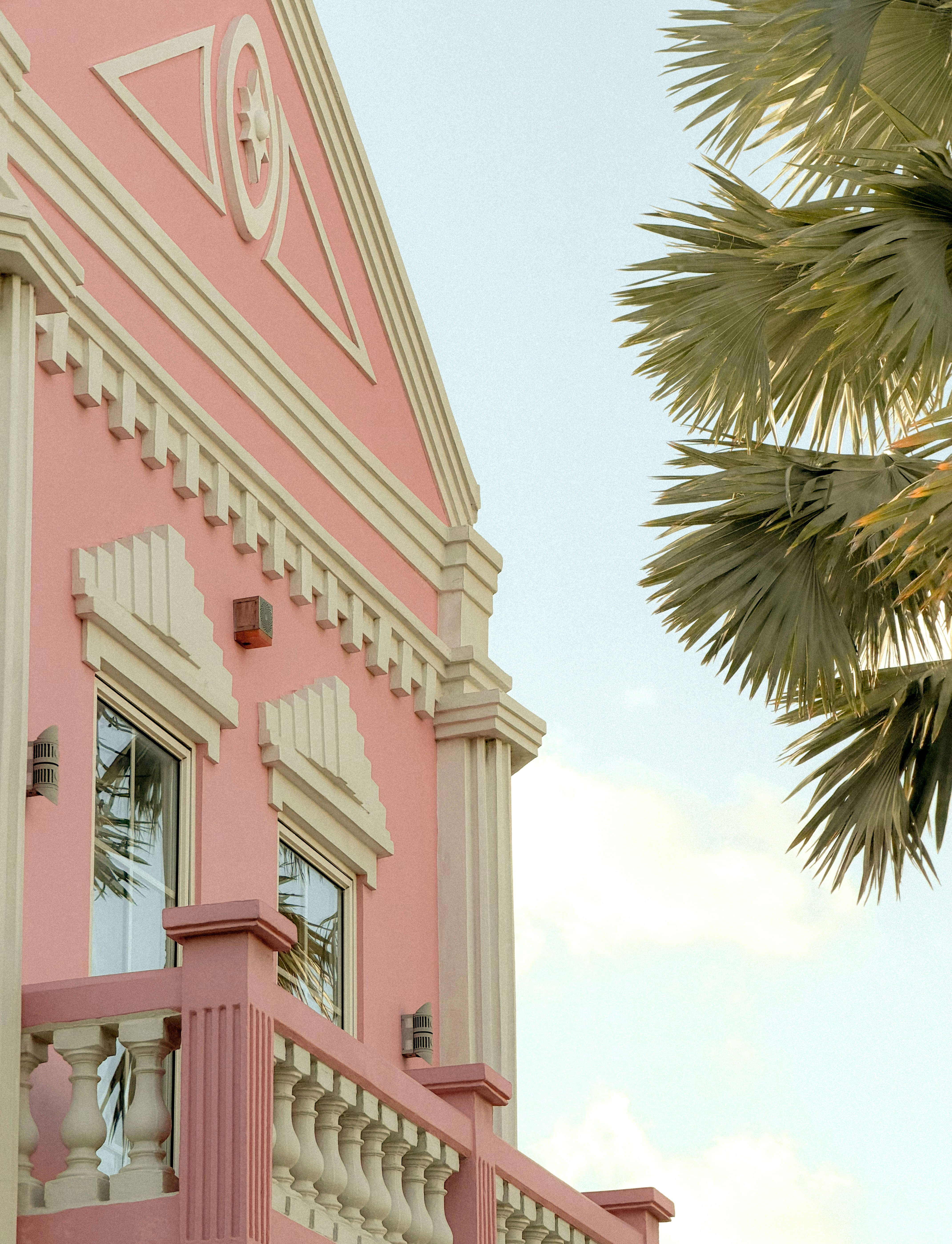 Pastel Facade of Coastal Clubhouse Bathed in Afternoon Light