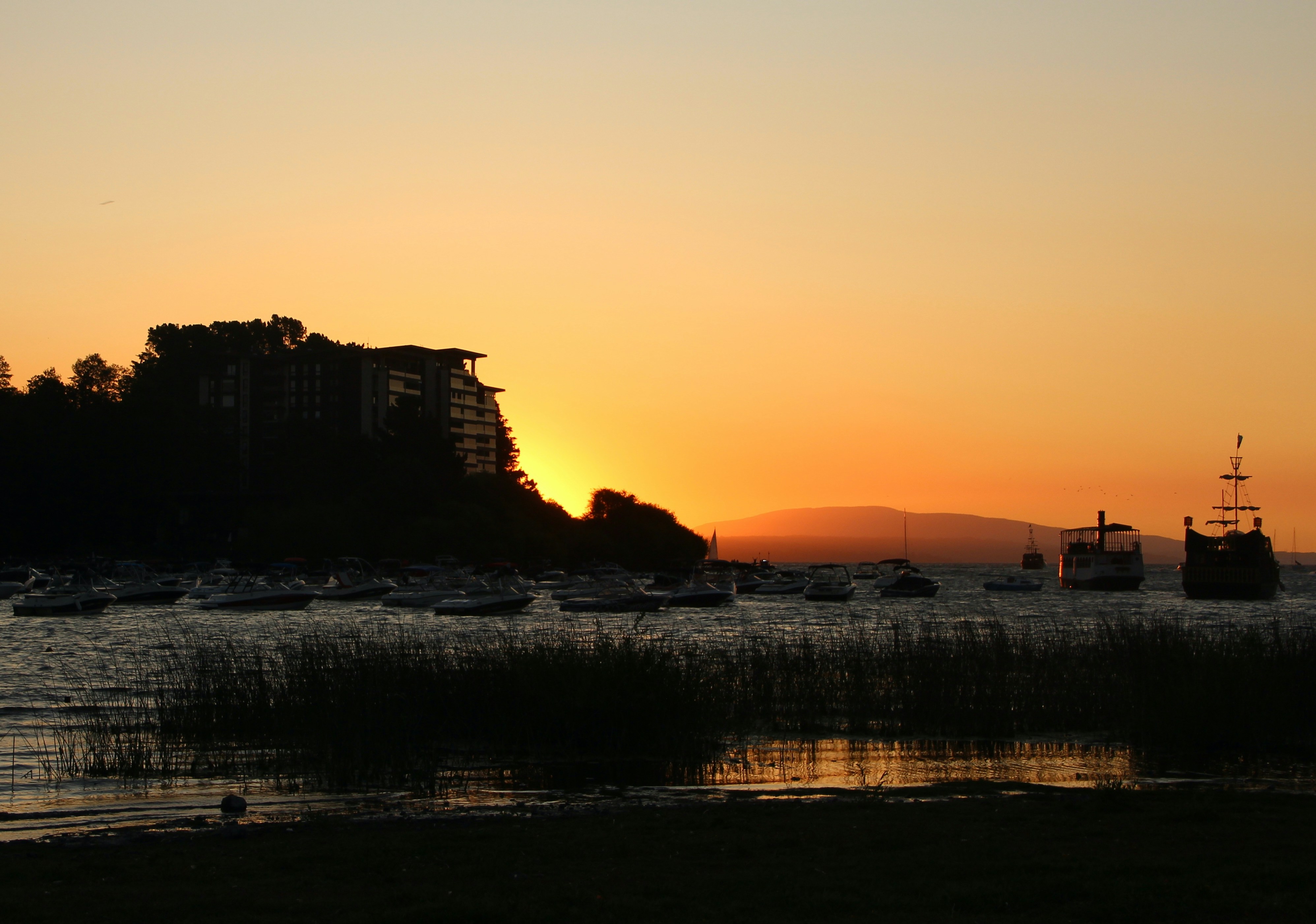 Sunset Silhouette Over Quiet Boats