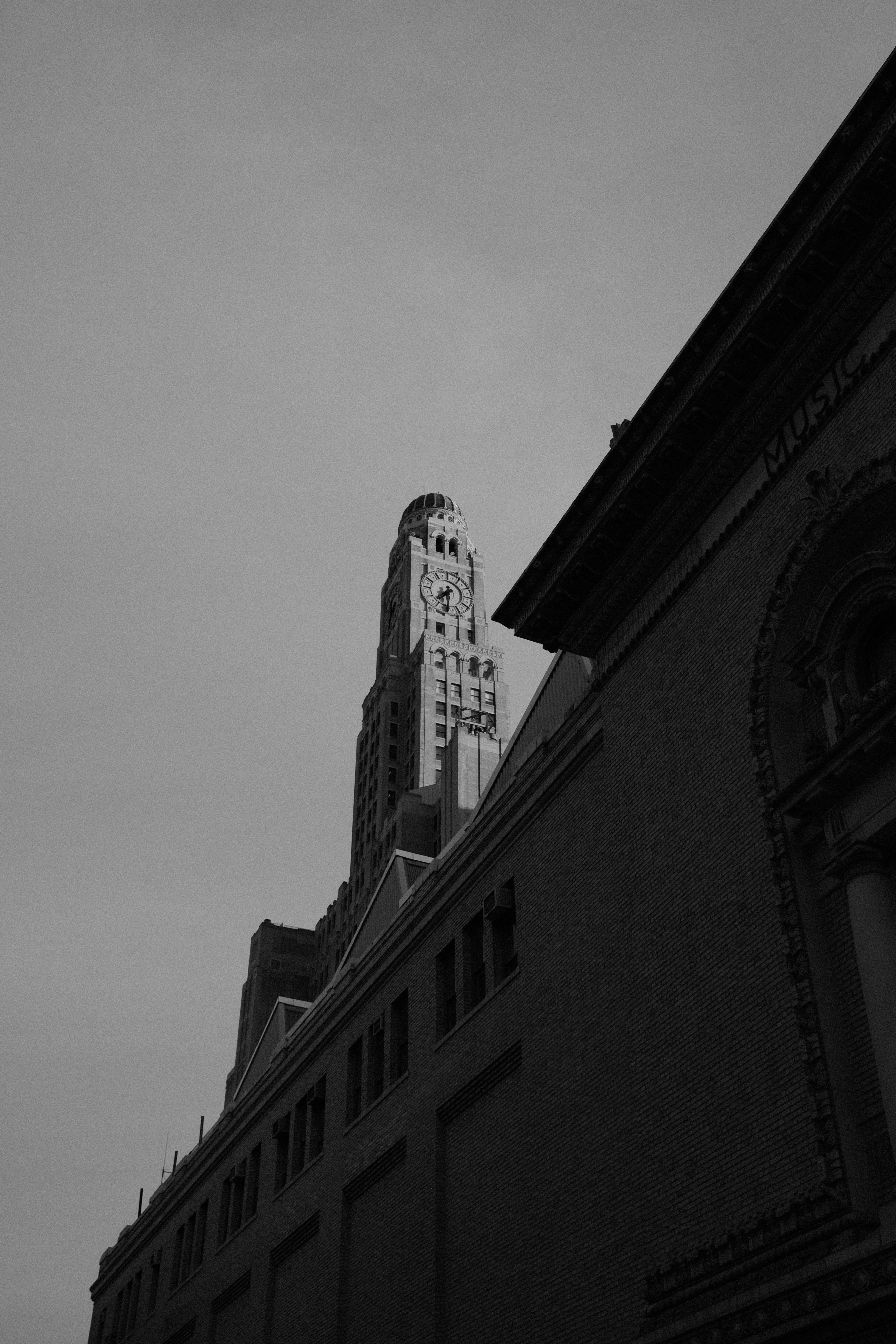 Ornate skyscraper towering over a dark urban building.