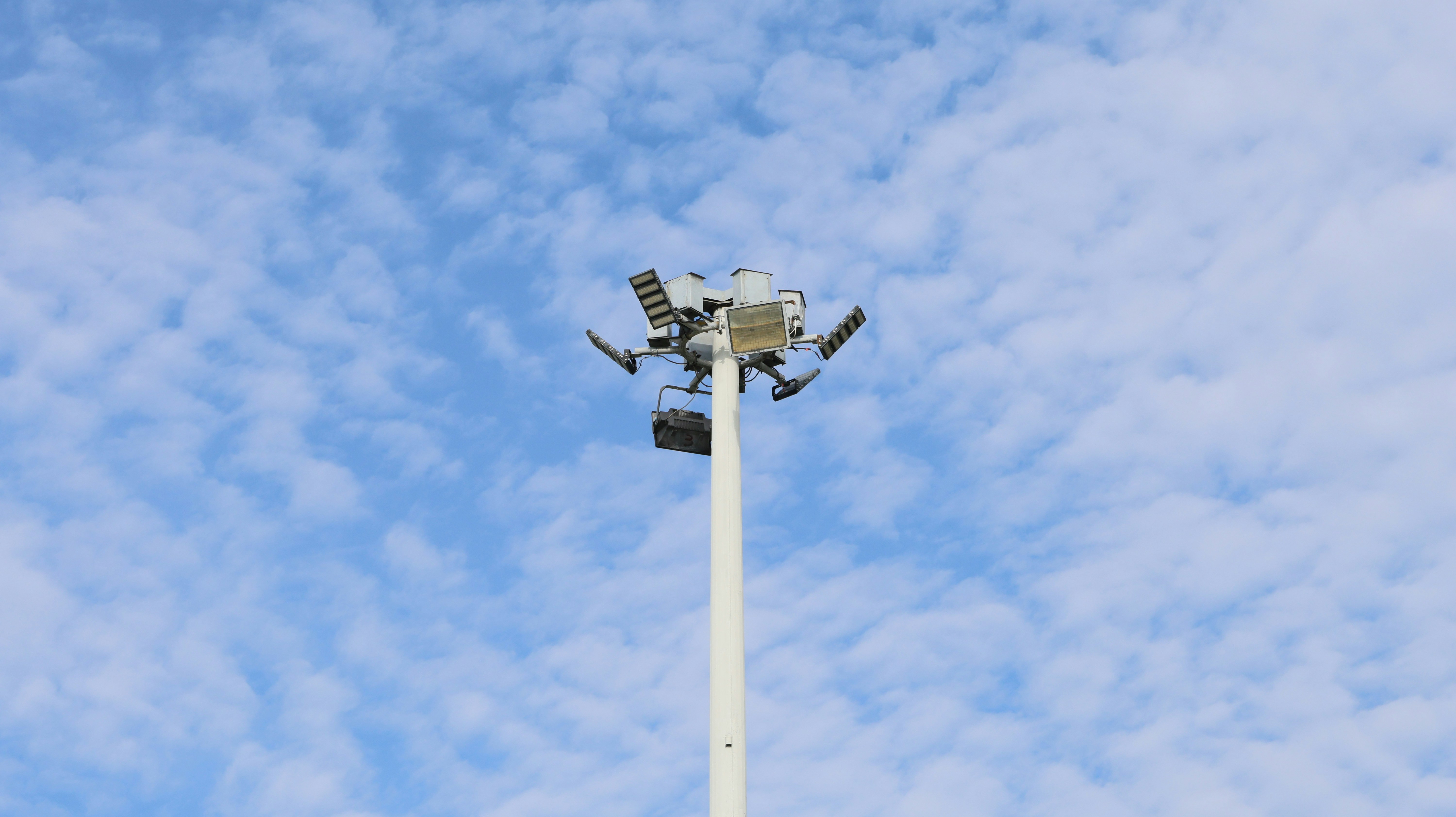 Beacon Above the Clouds: A Stadium Light Reaching for the Sky