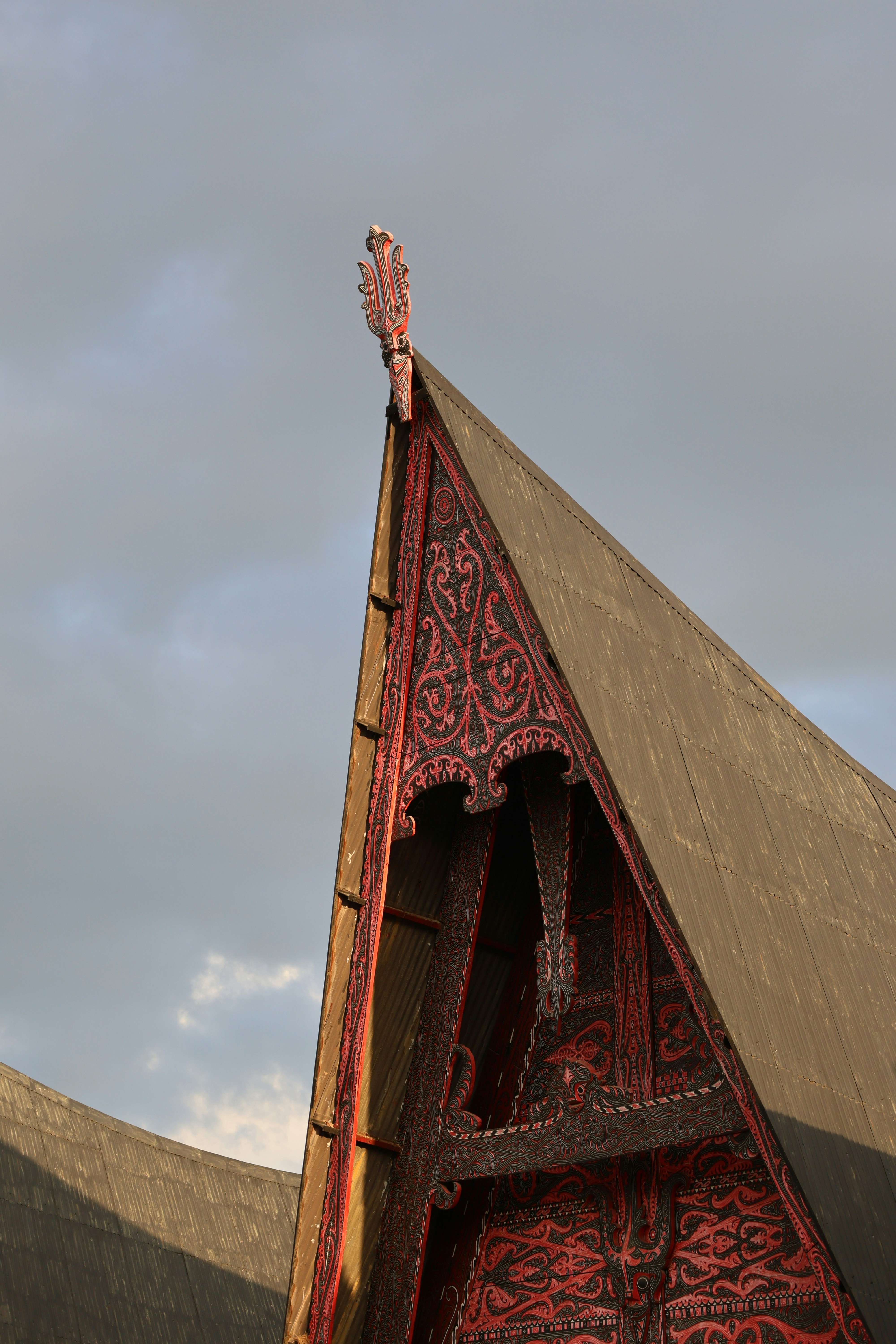 Architectural Carved Gable: A Gothic-Influenced Peak with Ornate Red Timberwork