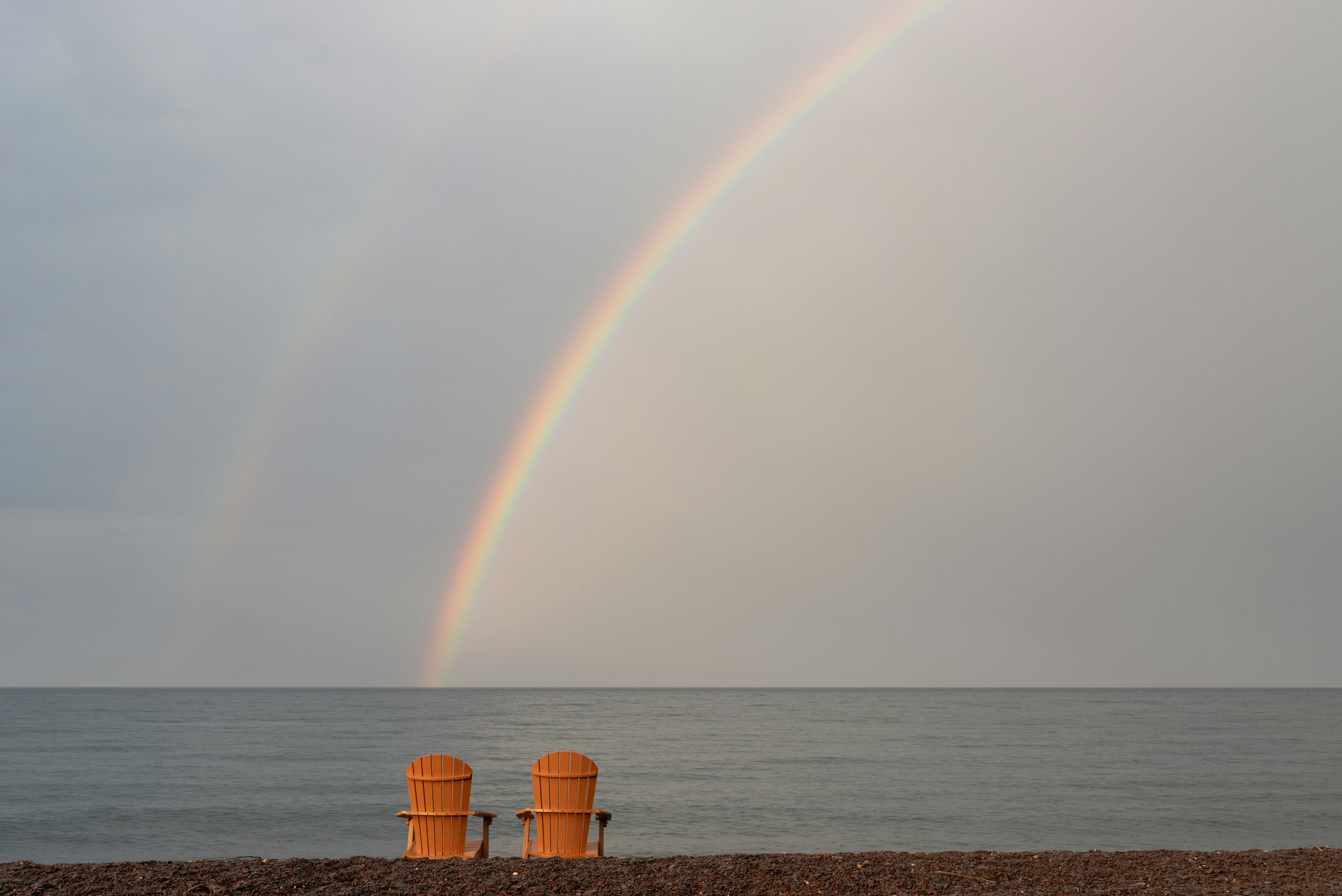 Twin Rainbows Over a Serene Seaside Retreat