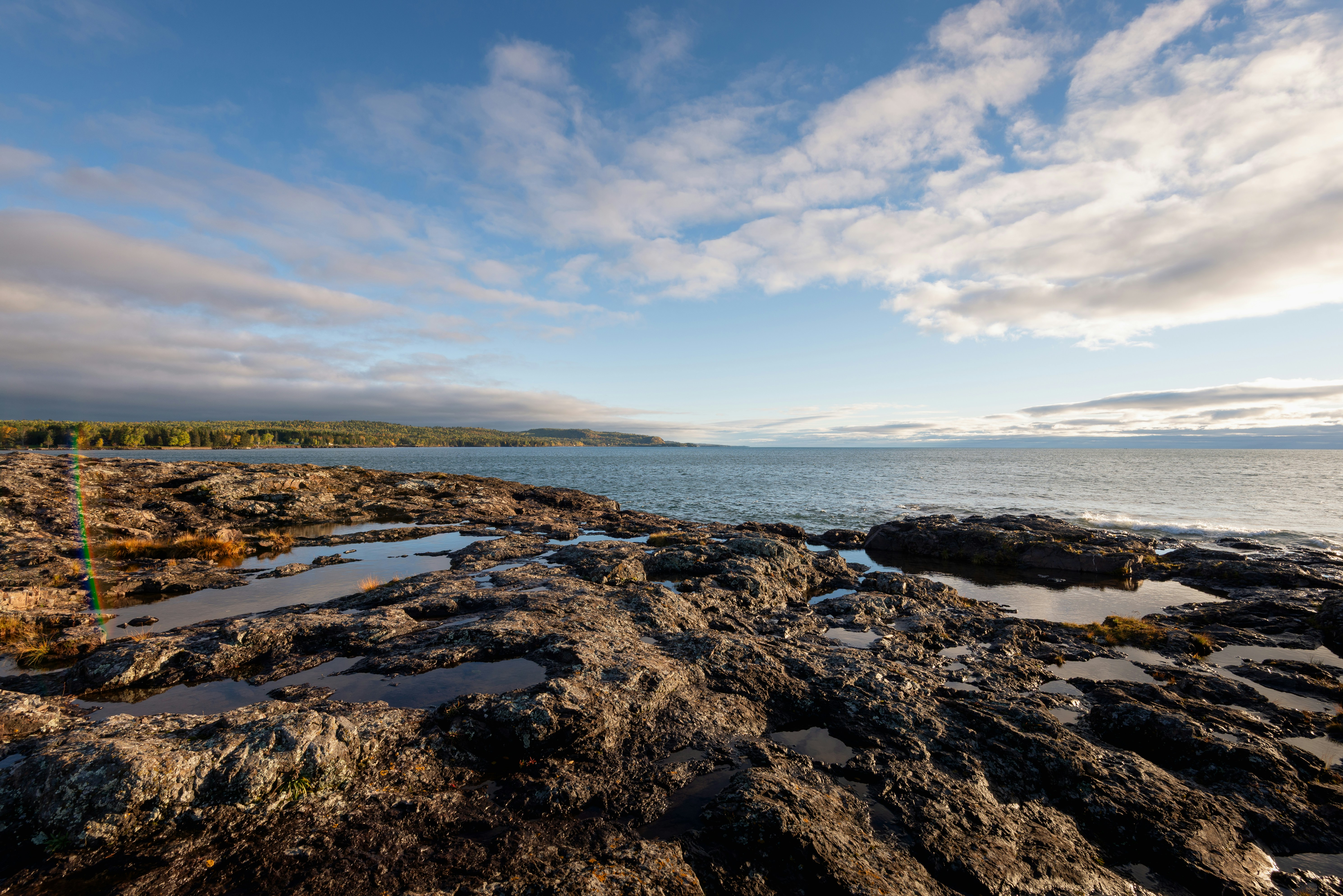 Rugged shoreline under a canvas of drifting clouds