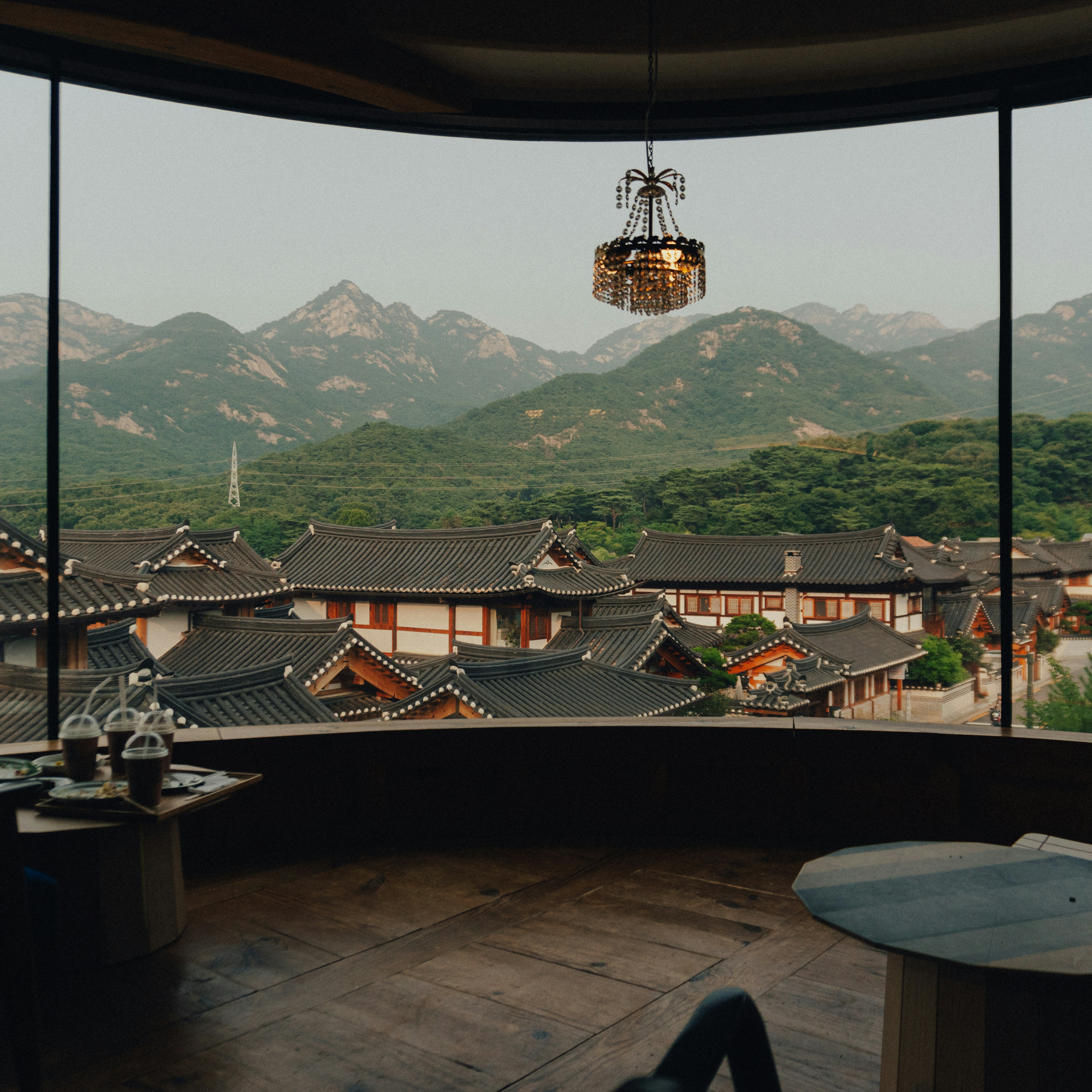 Bay Window Overlooking Traditional Roofs and Mountain Ridge