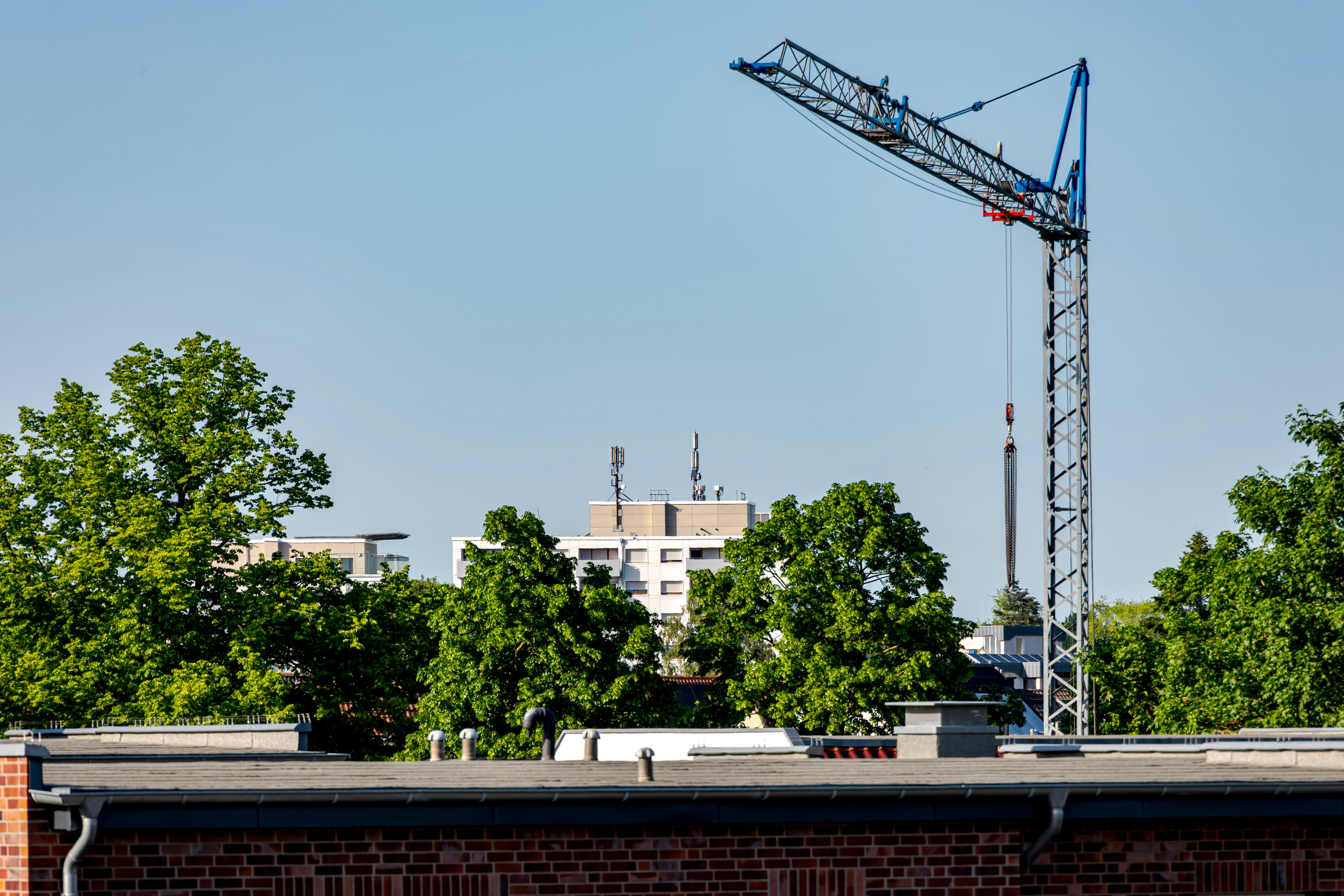 Rooftop Scene with Tower Crane Above a Quiet Urban Edge