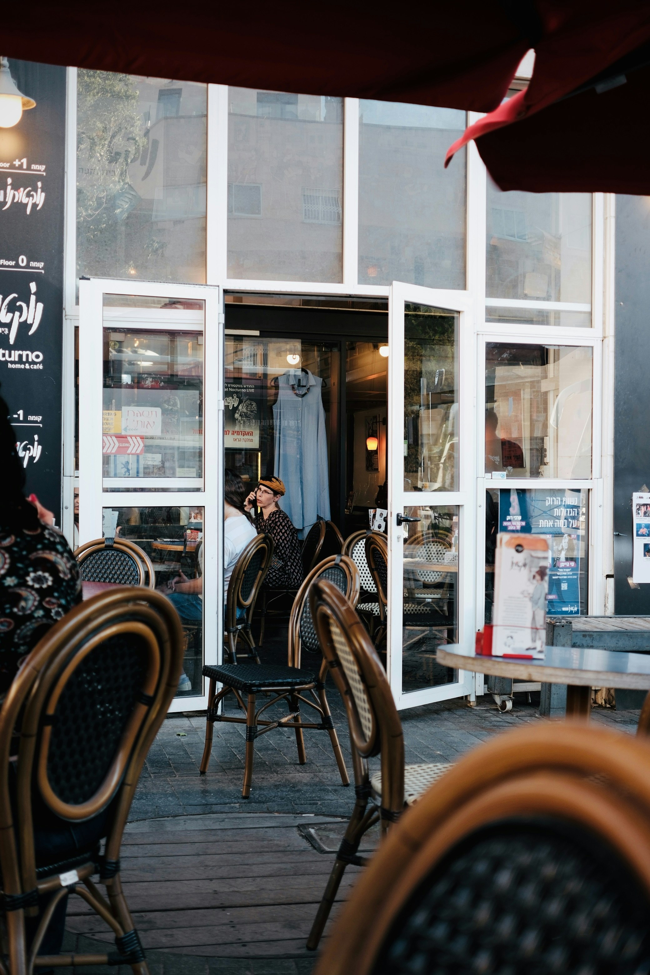 Cafe Contemplation Through Glass: Passersby and Pastries Inside a Parisian-Style Bistro