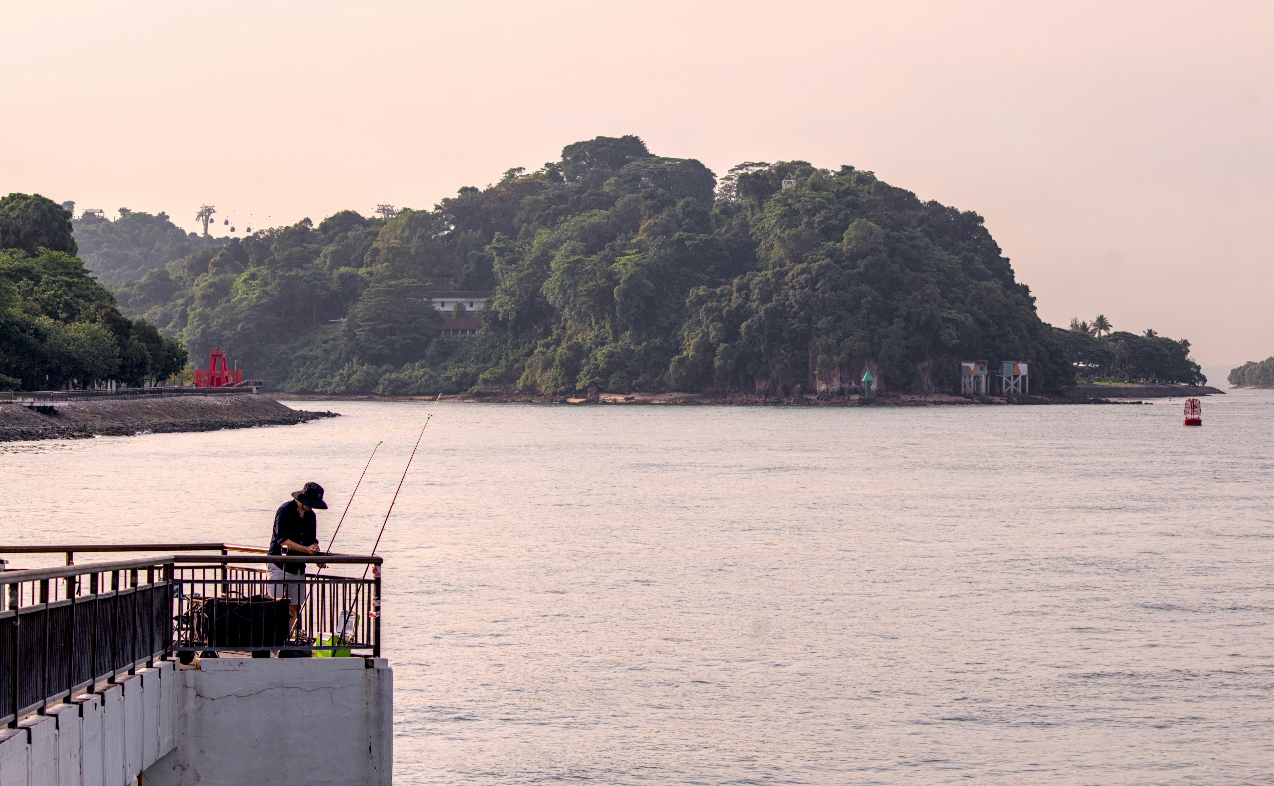 Harbor Vantage: Fisherman at the Edge of a Quiet Bay