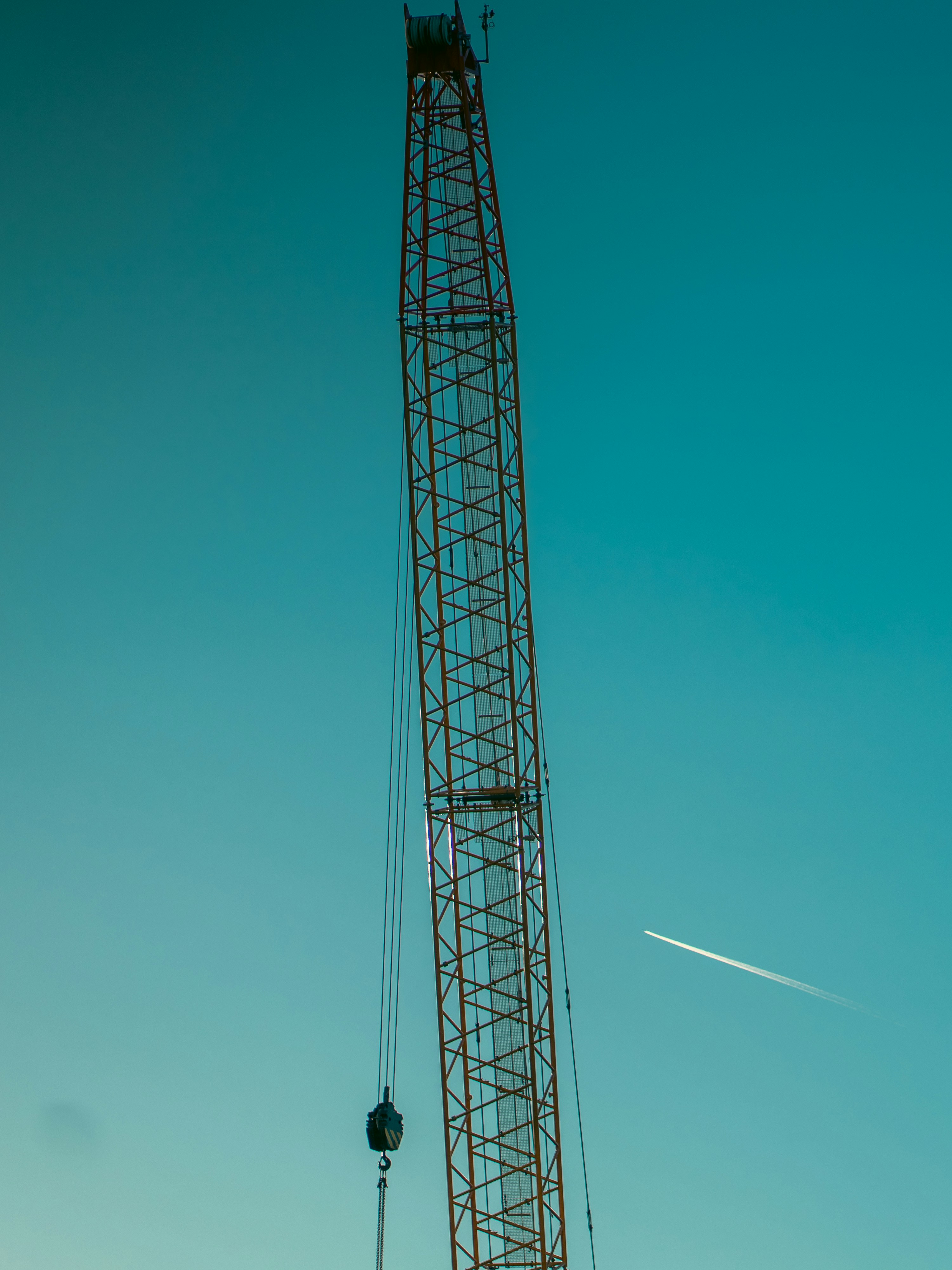 Crane Tower Reaching Toward a Teal Sky