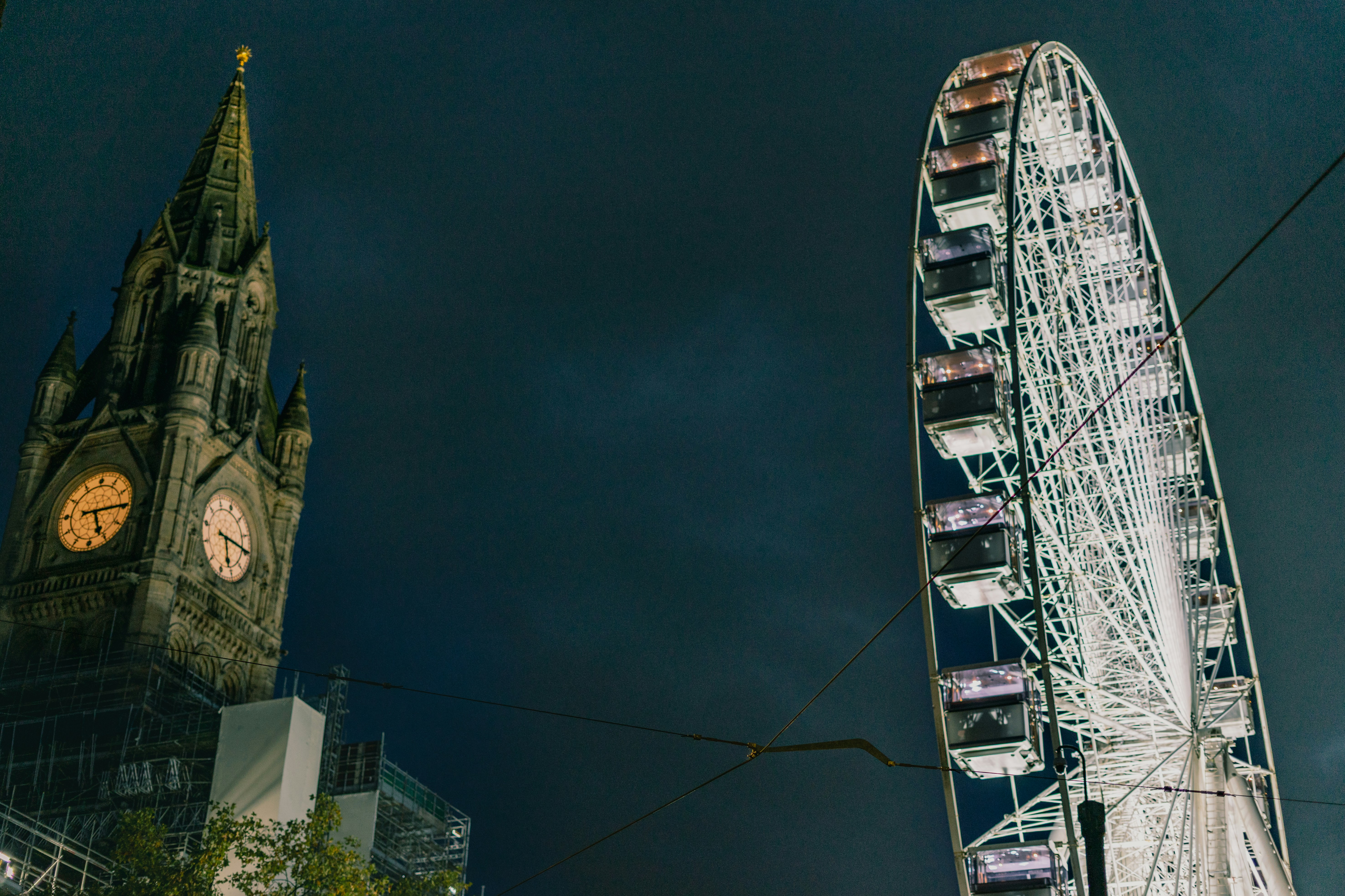 Nighttime Spin: The Ferris Wheel Koalares the Skyline beside Big Ben