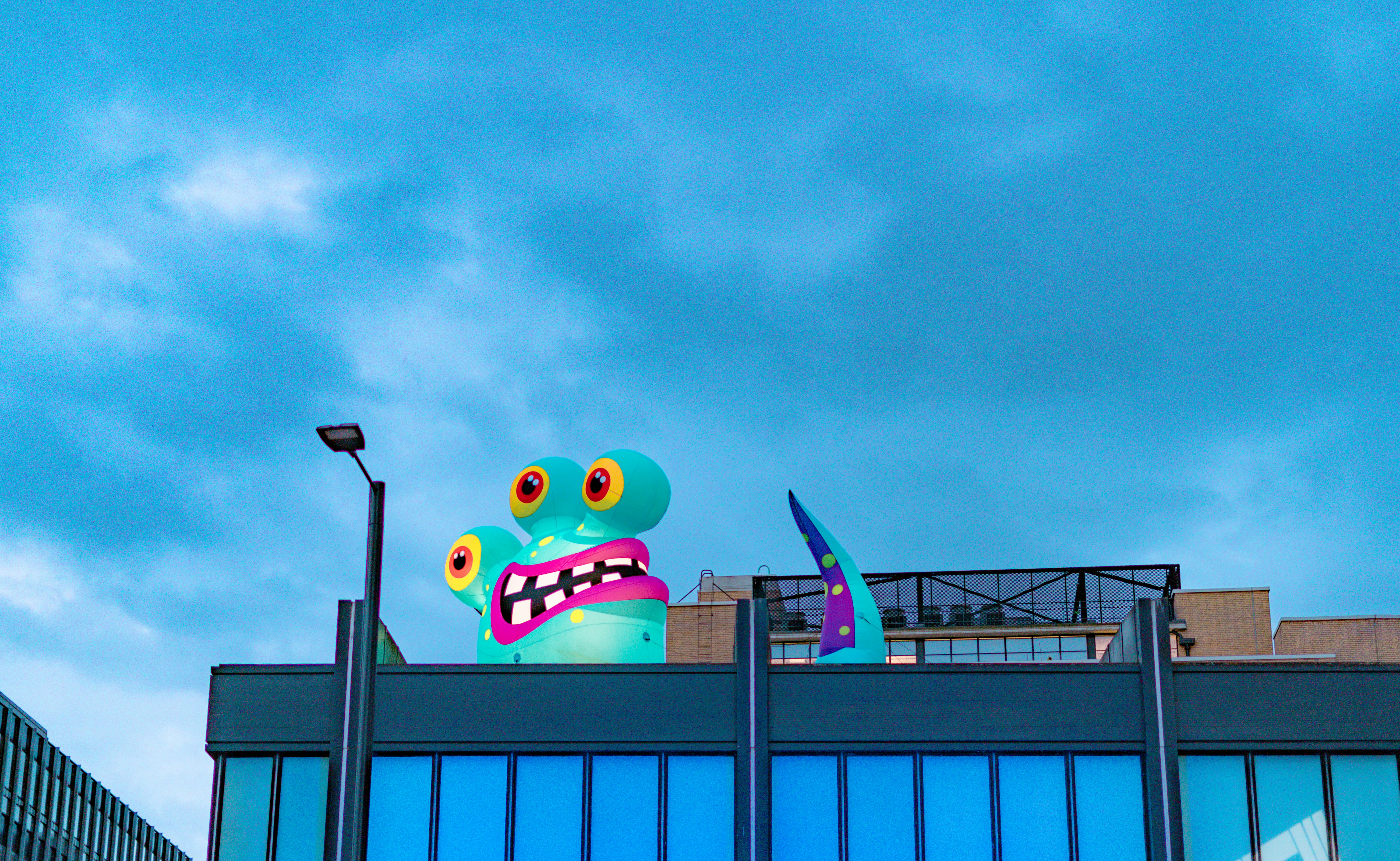 Neon Monster Overwatch: An Office Roof Demi-God Keeps Watch