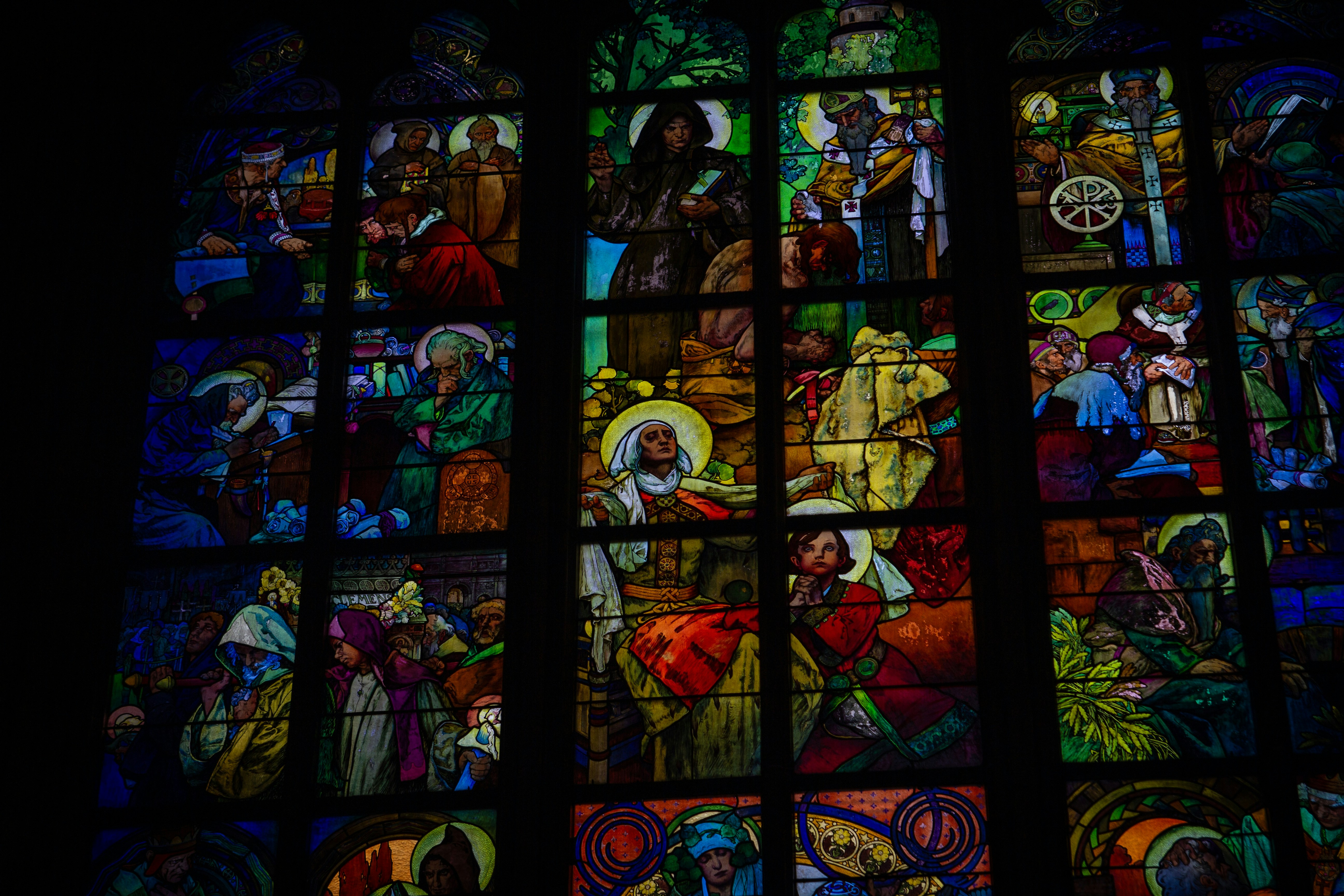 Stained Glass Sermon: A Mosaic of Colorful Figures in Quiet Light