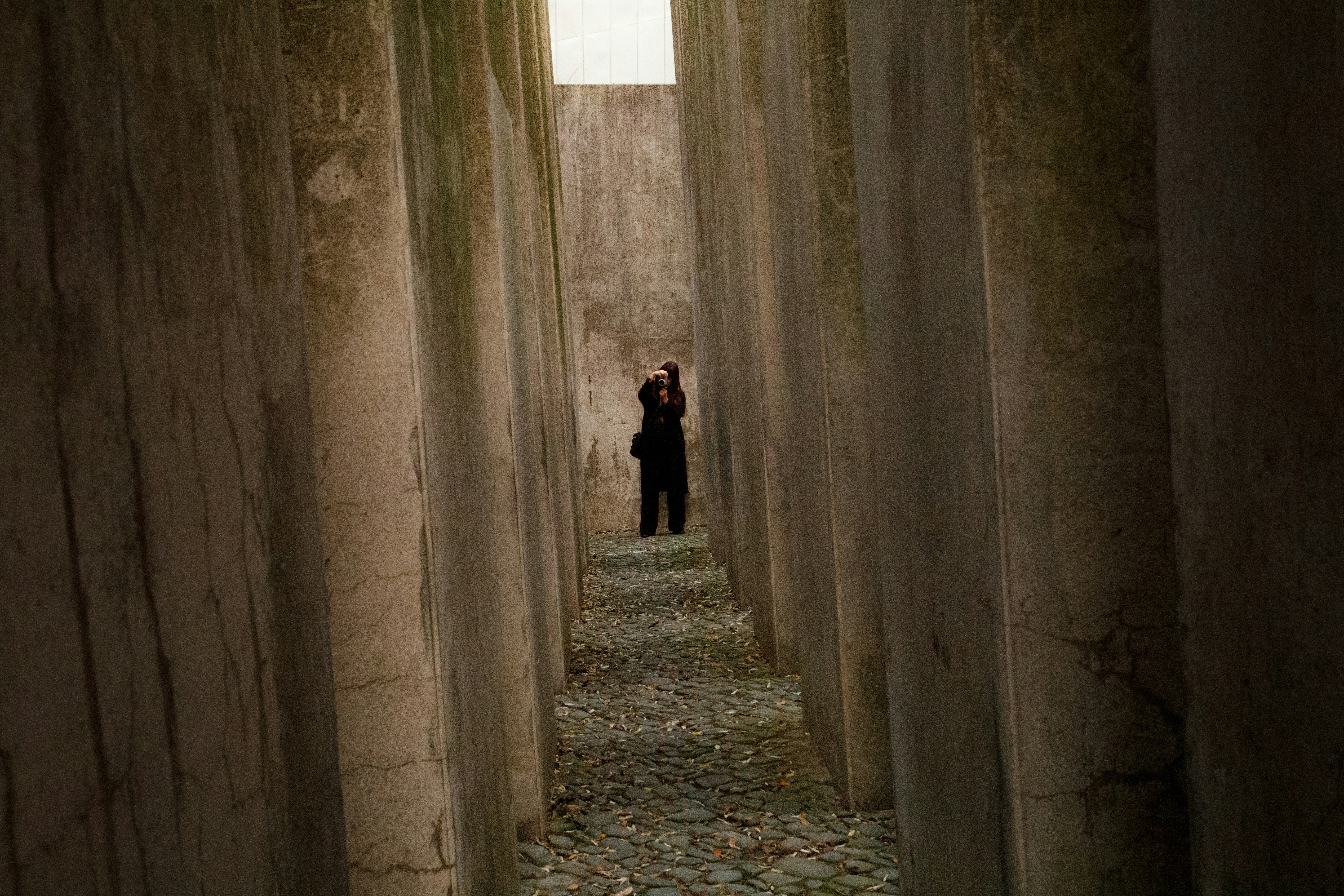 Between Columns: A Quiet Embrace in the Stone Corridor