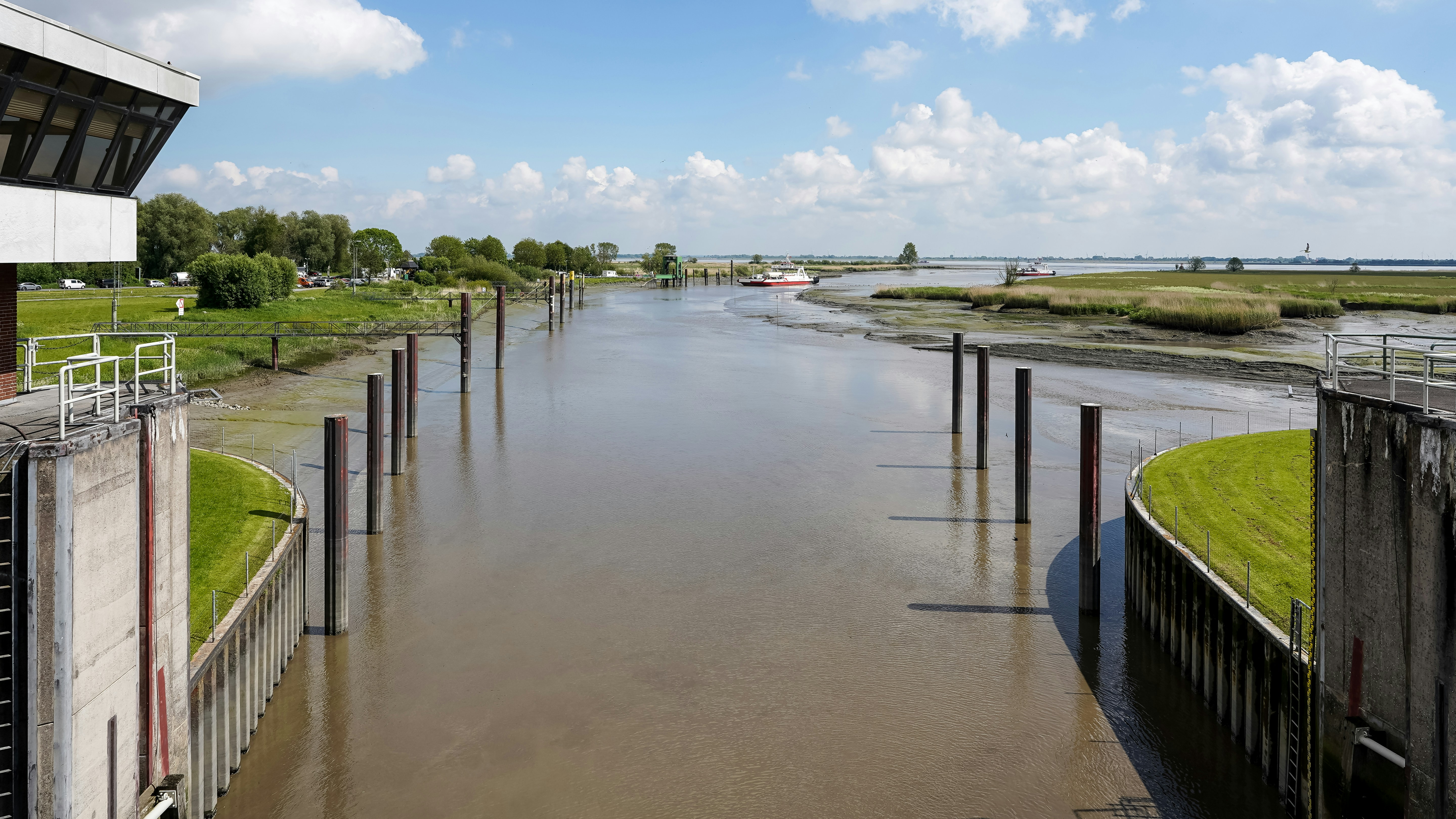 Bridge Over Calm Tidal Channel at Dappled Shoreline