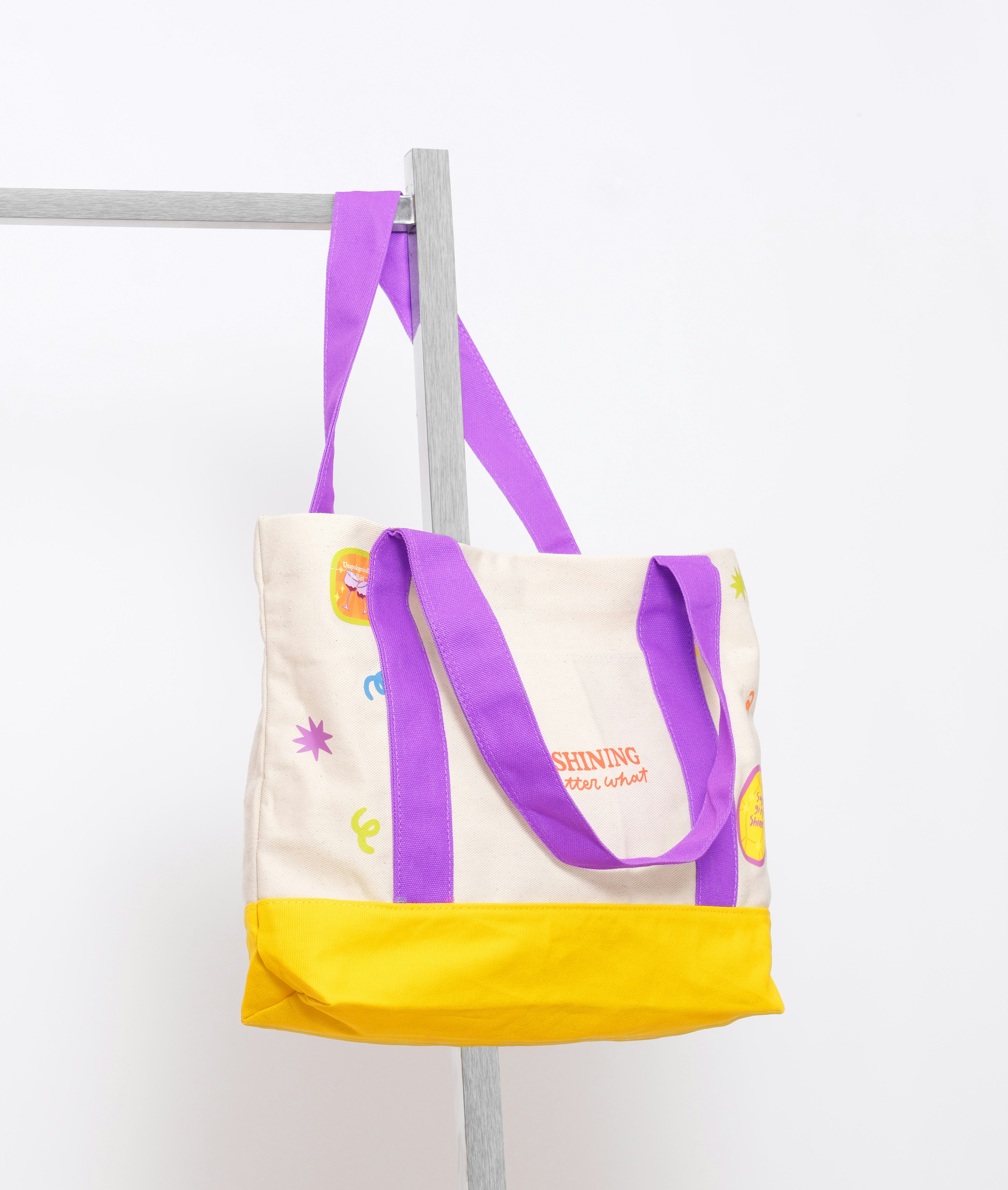 Colorful tote on a minimalist stand: a bright pop of purple and yellow